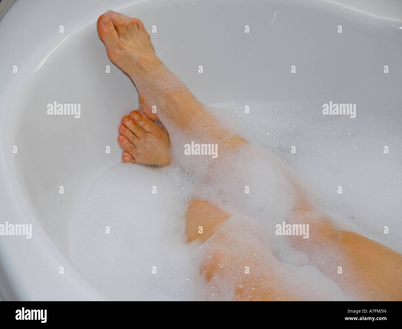legs looking out from bubble bath foam bath Stock Photo - Alamy