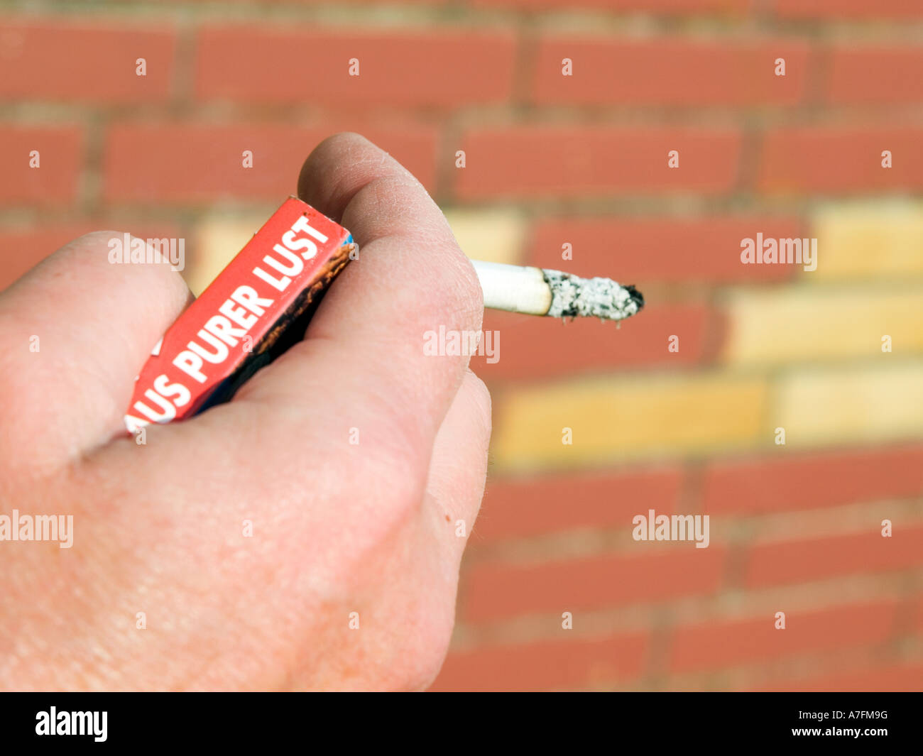 MR smoker in open air hand holding a cigarette and a matchbox with ...