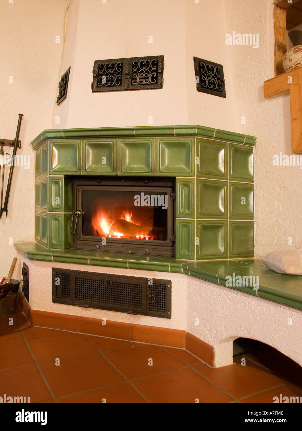 tiled stove burning with firewood in typical German way Stock Photo - Alamy