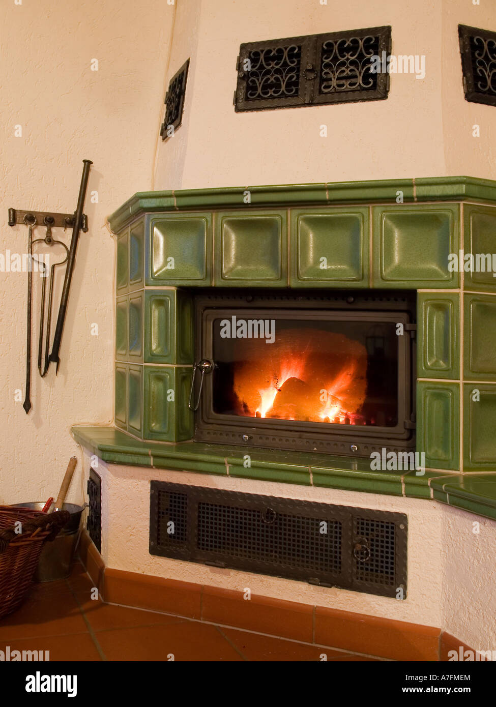 tiled stove burning with firewood in typical German way Stock Photo - Alamy