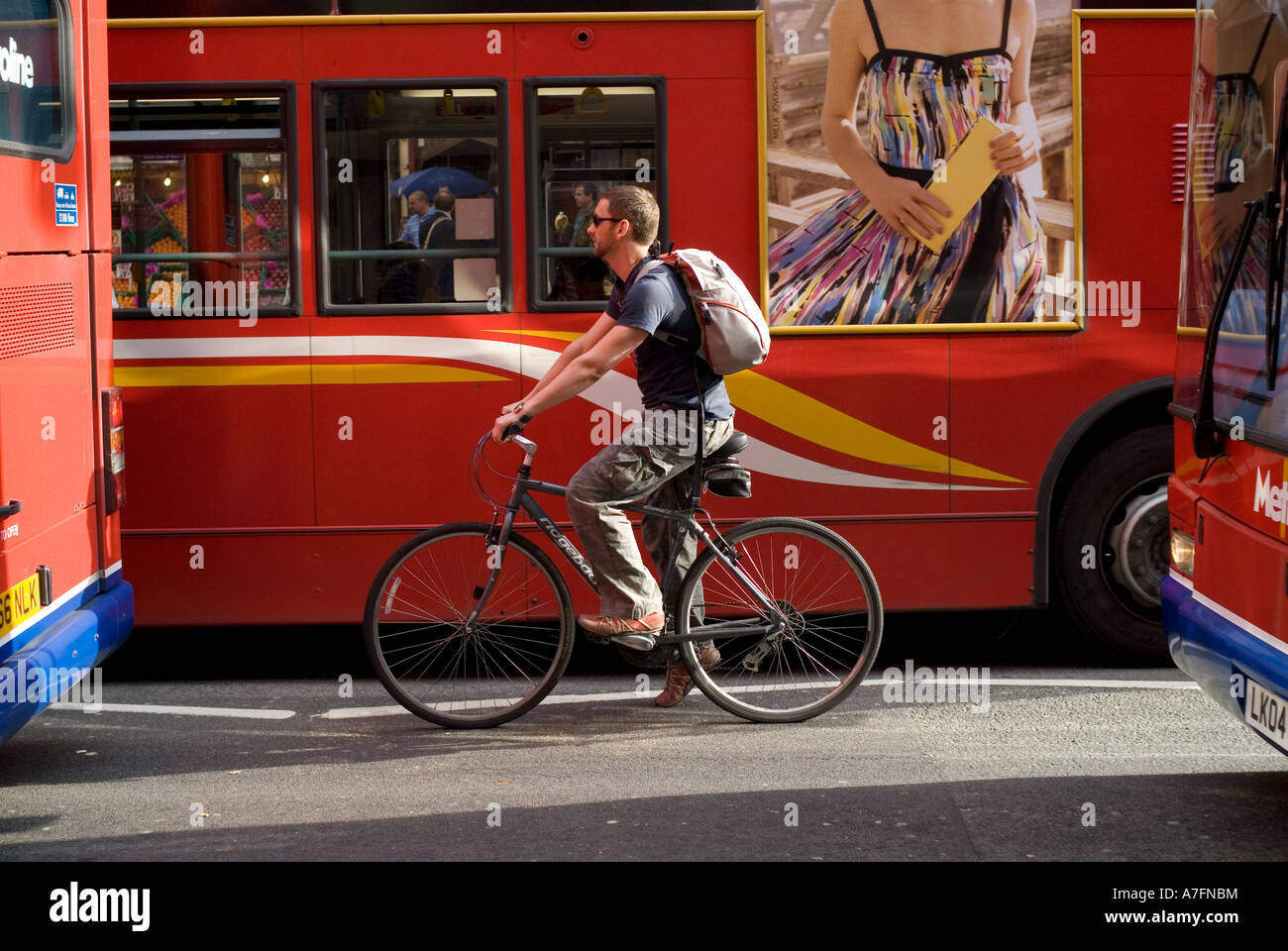 Bicycle surrounded by buses in London Stock Photo - Alamy