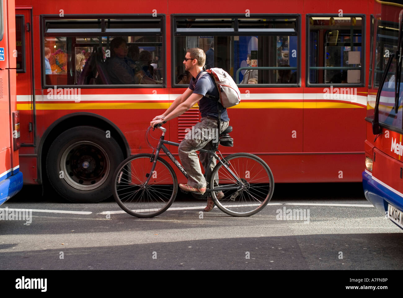 Bicycle surrounded by buses in London Stock Photo - Alamy