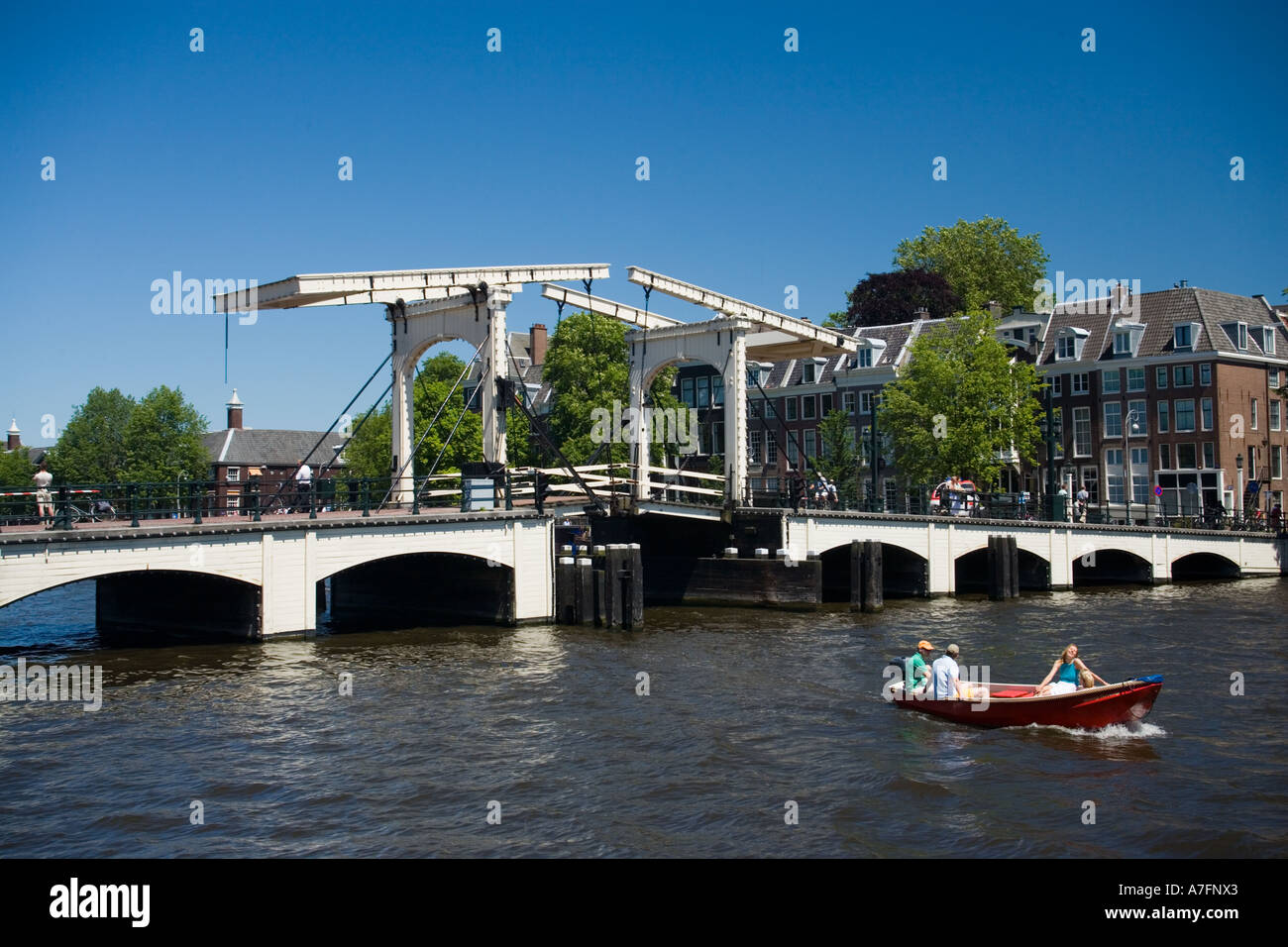View over Amstel with leisure boat to Magere Brug Skinny Bridge ...