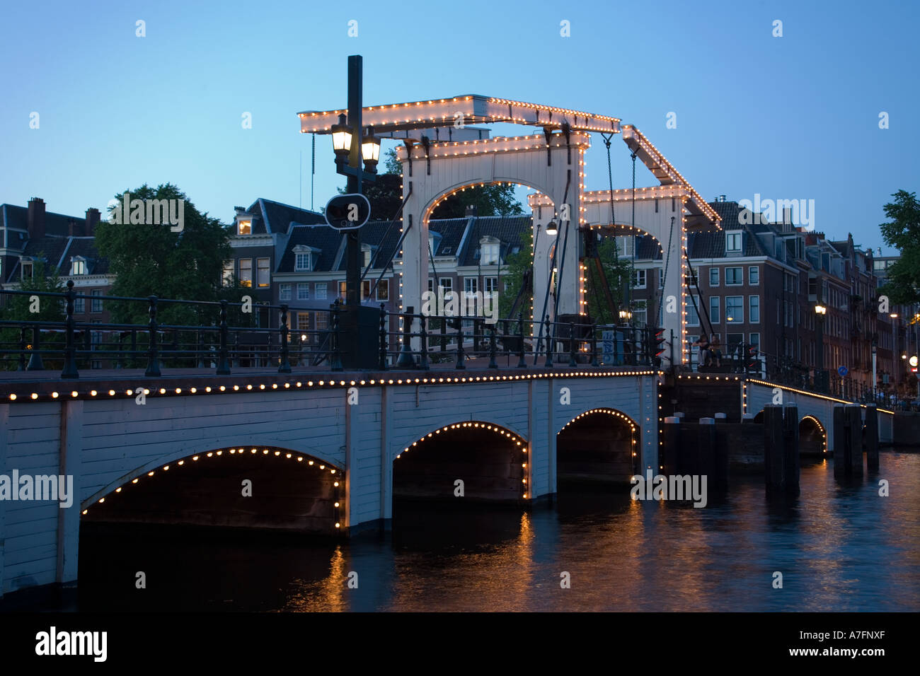 Illuminated Magere Brug Skinny Bridge in the evening Amsterdam Holland ...