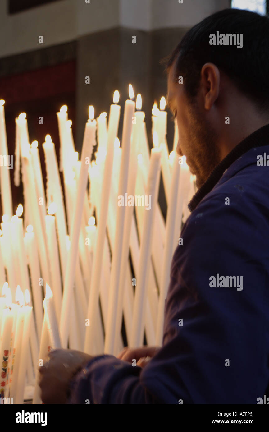Man lighting votive candles hi-res stock photography and images - Alamy