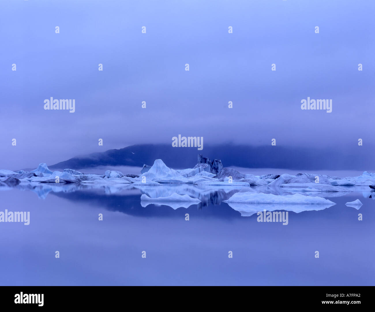 Iceberg, reflection; low clouds. Russell Fiord Wilderness. Tongass ...