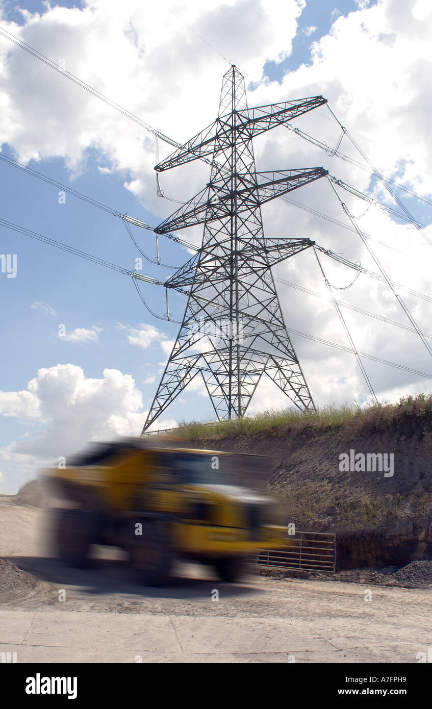 Earthmover & electricity pylon Stock Photo - Alamy
