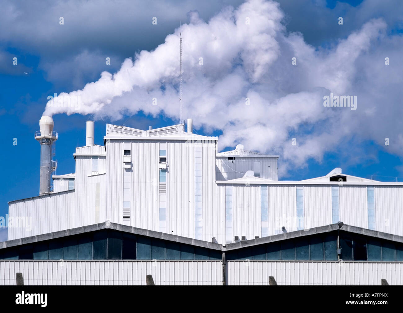factory blowing out white smoke from chimney Stock Photo - Alamy