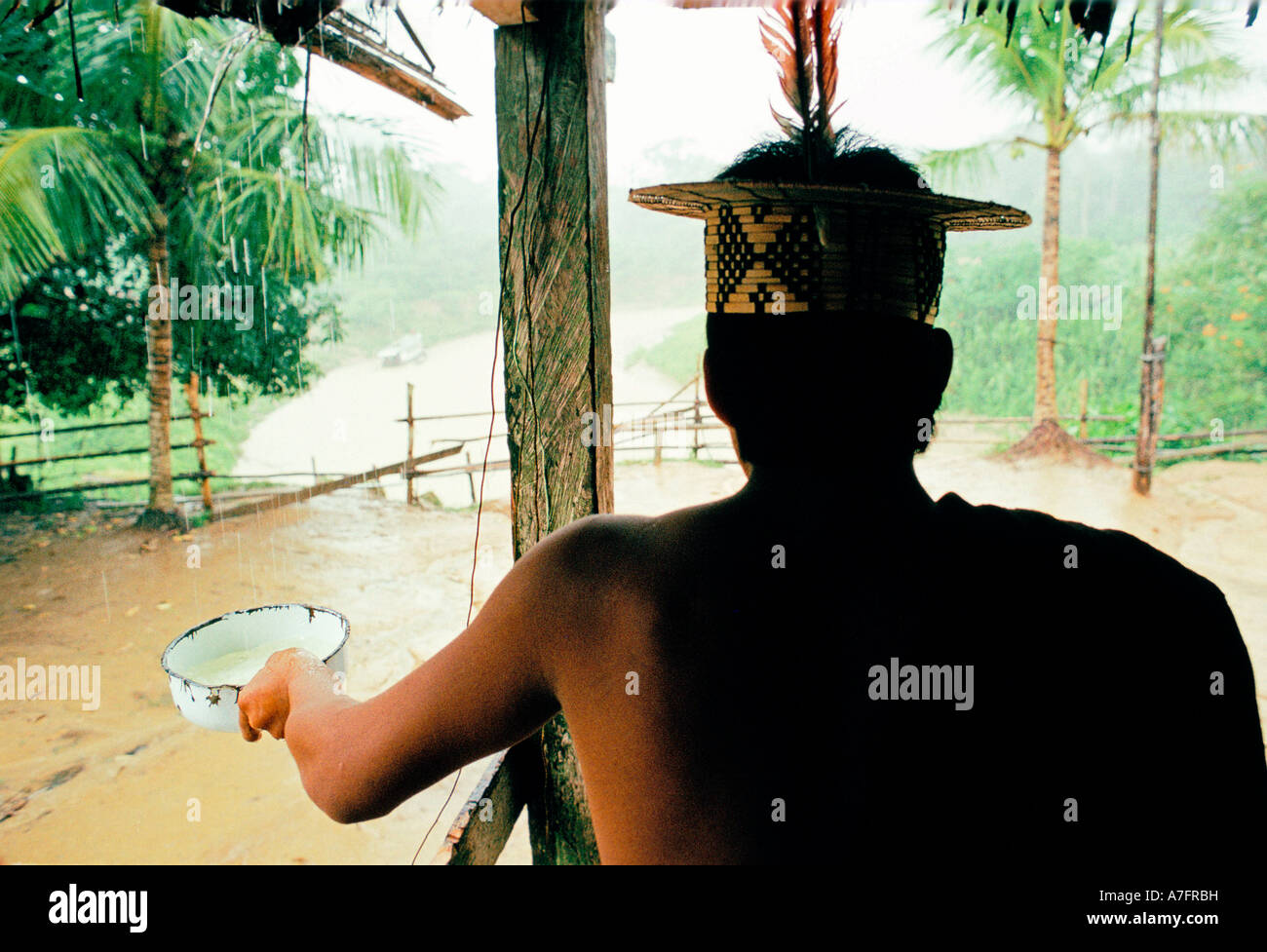 Catching rainwater in a metal bowl Stock Photo - Alamy