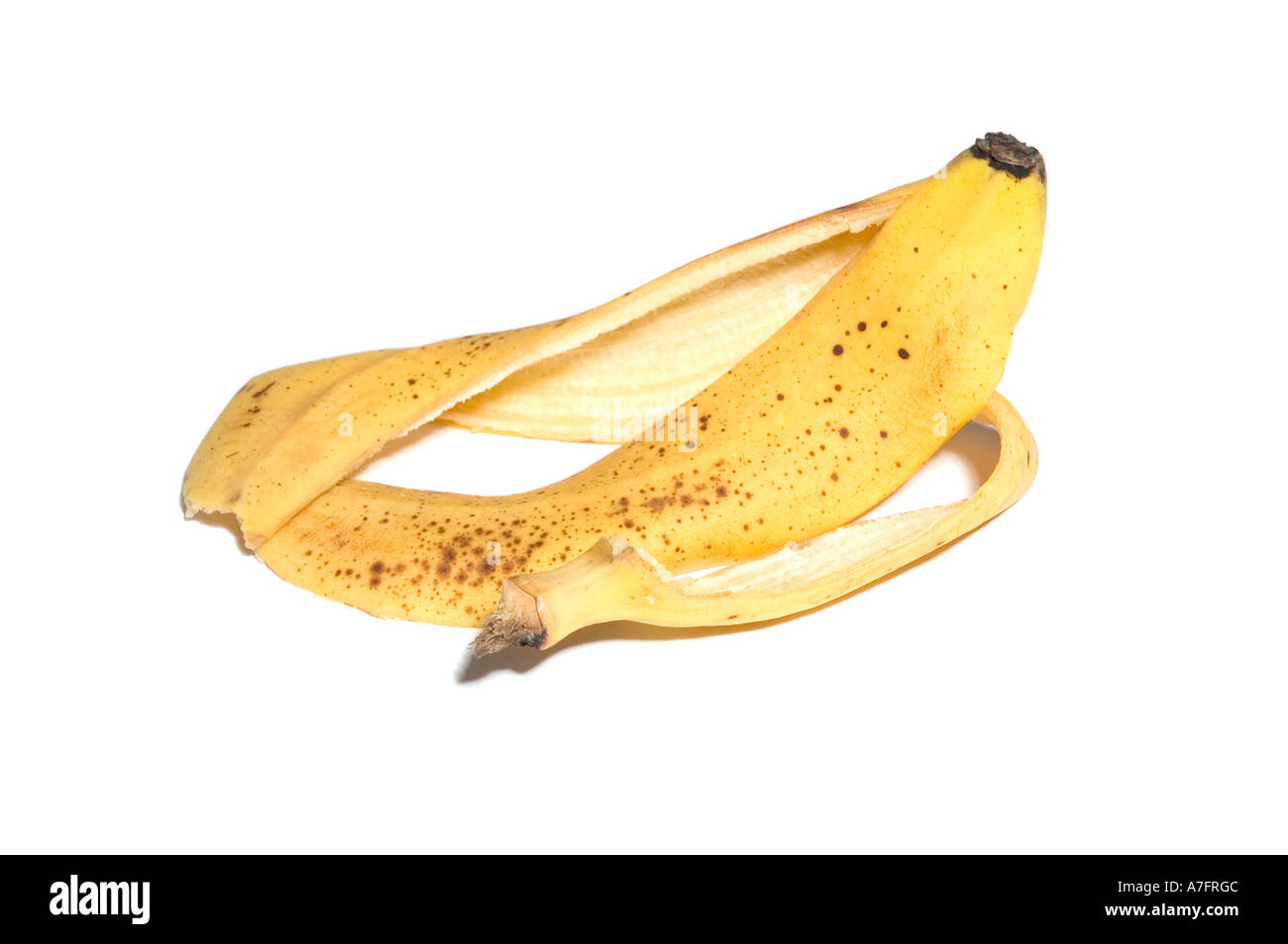 Peeled open banana skin sitting on white Stock Photo - Alamy