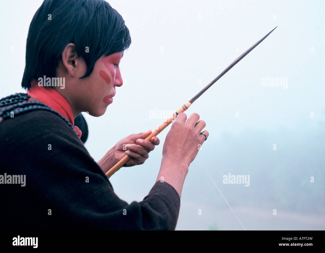 Decorating an arrow with thread Stock Photo - Alamy