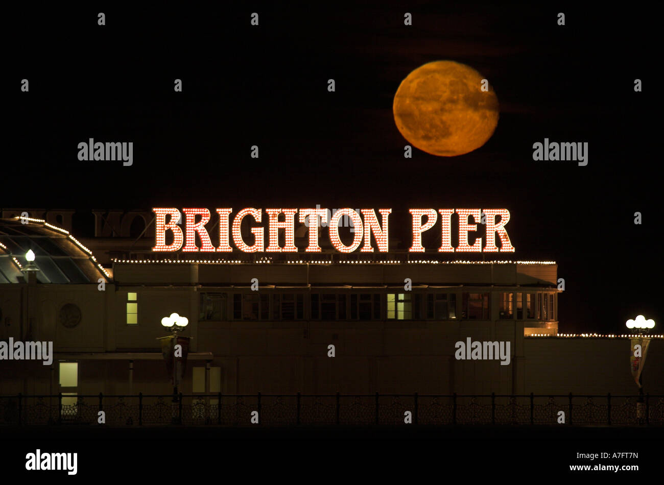 BRIGHTON PIER sign at night full moon behind Brighton Sussex UK Stock ...