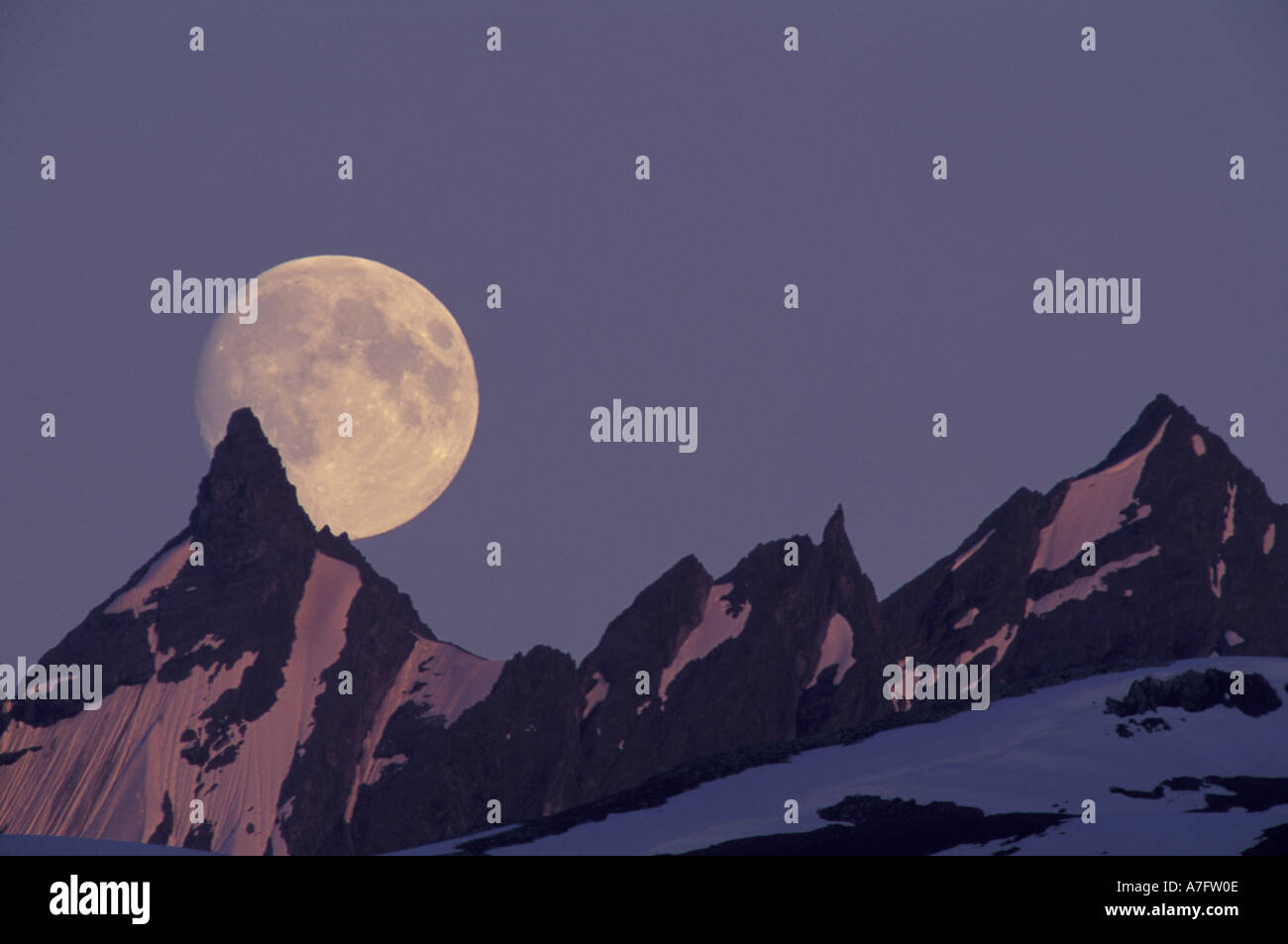 Alaska, Chugach Mountains Full moon rises behind jagged Chugach ...