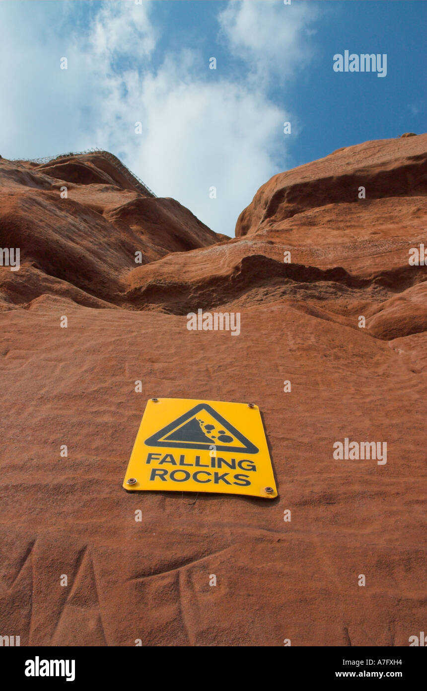 Falling Rocks sign on coastal sandstone cliff in Sidmouth, Devon, UK ...