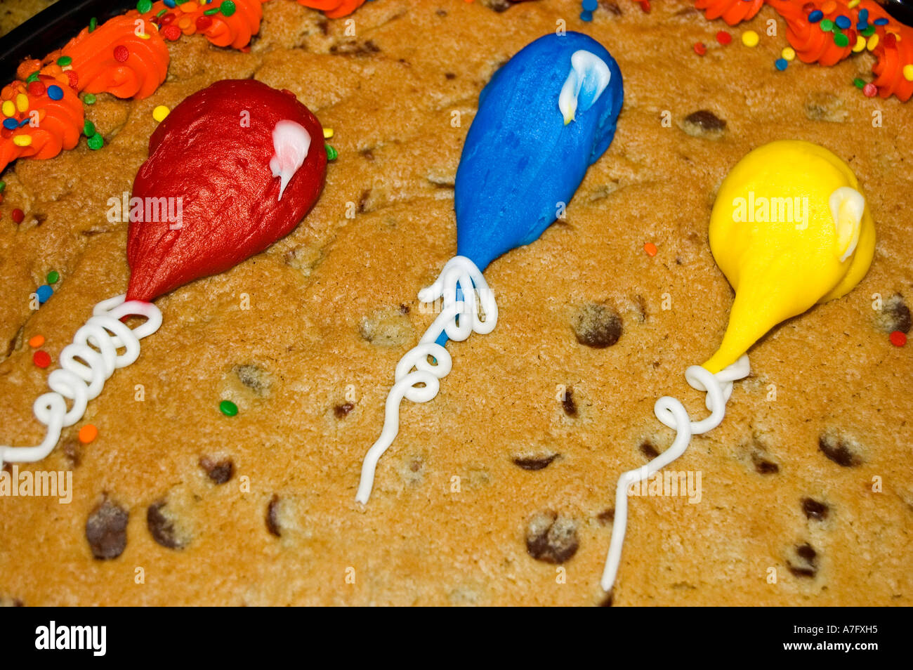 Balloon birthday decorations on chocolate chip cookie Stock Photo - Alamy