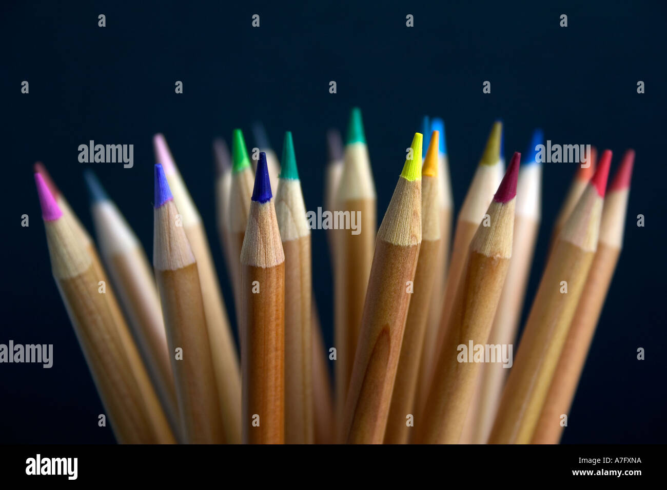 Landscape shot of sharp colour pencils in pot (pot unseen) standing ...