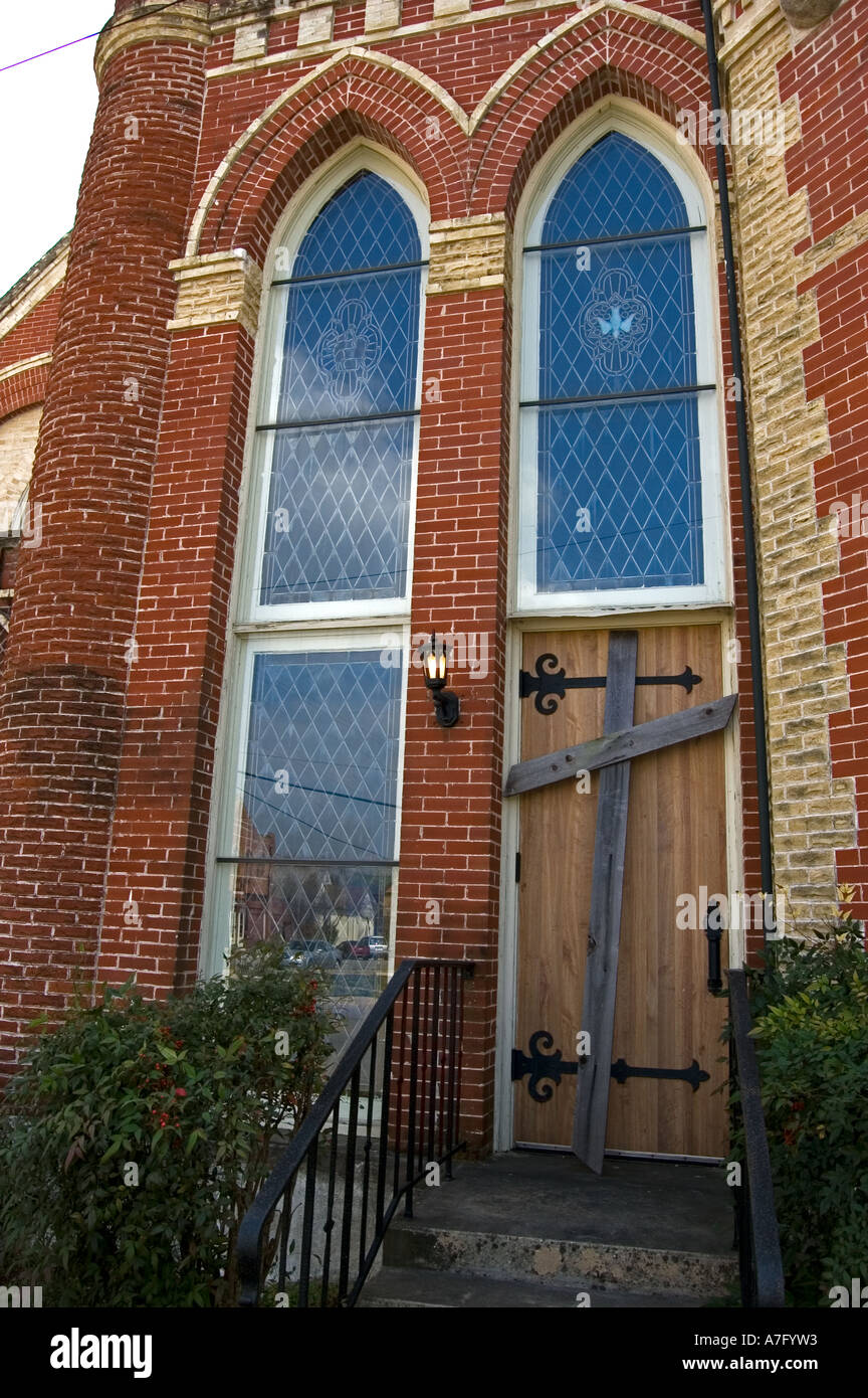 Church entrance with cross on door and arched windows Stock Photo - Alamy