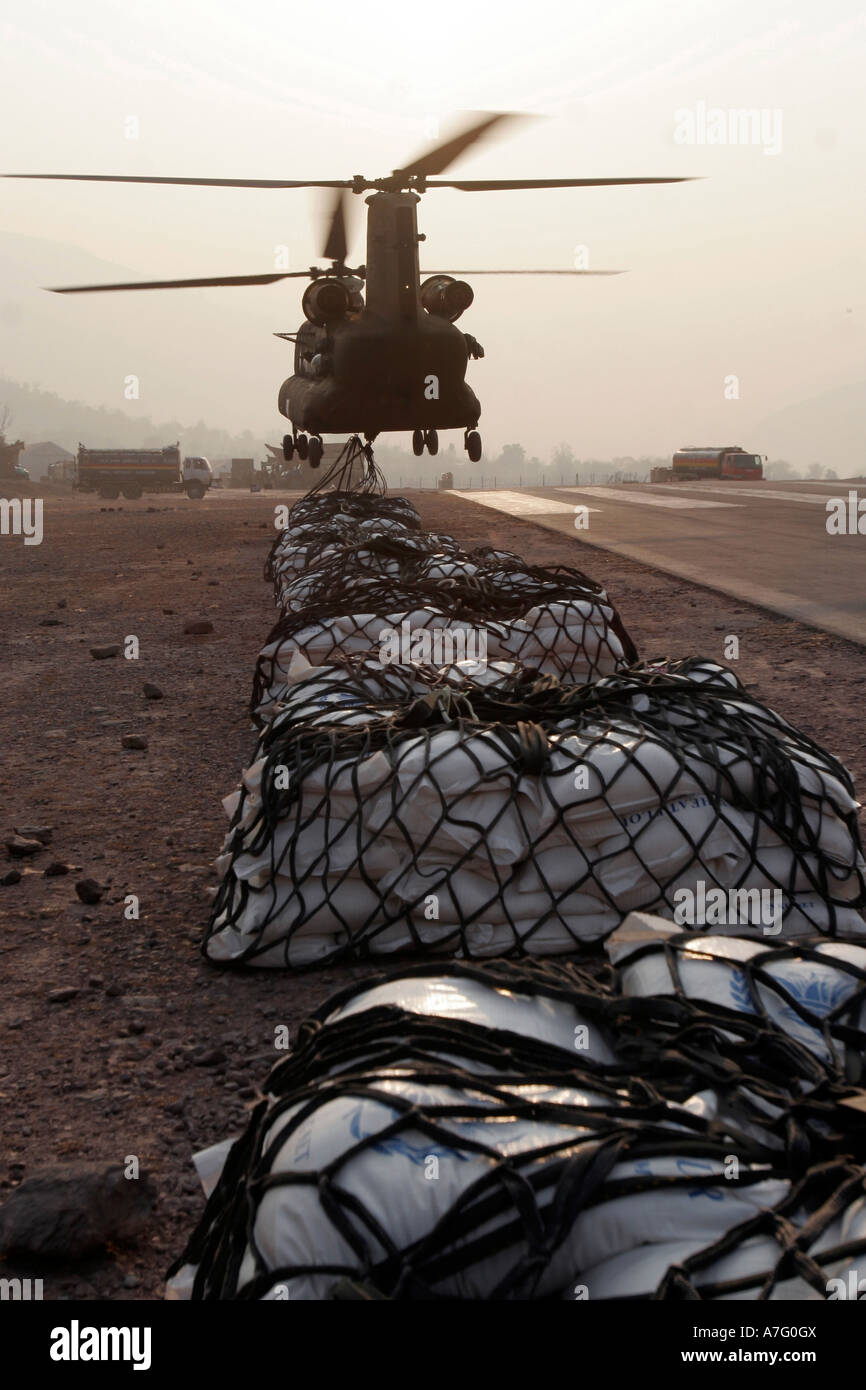 Marine landing support specialists attach external loads, or sling ...