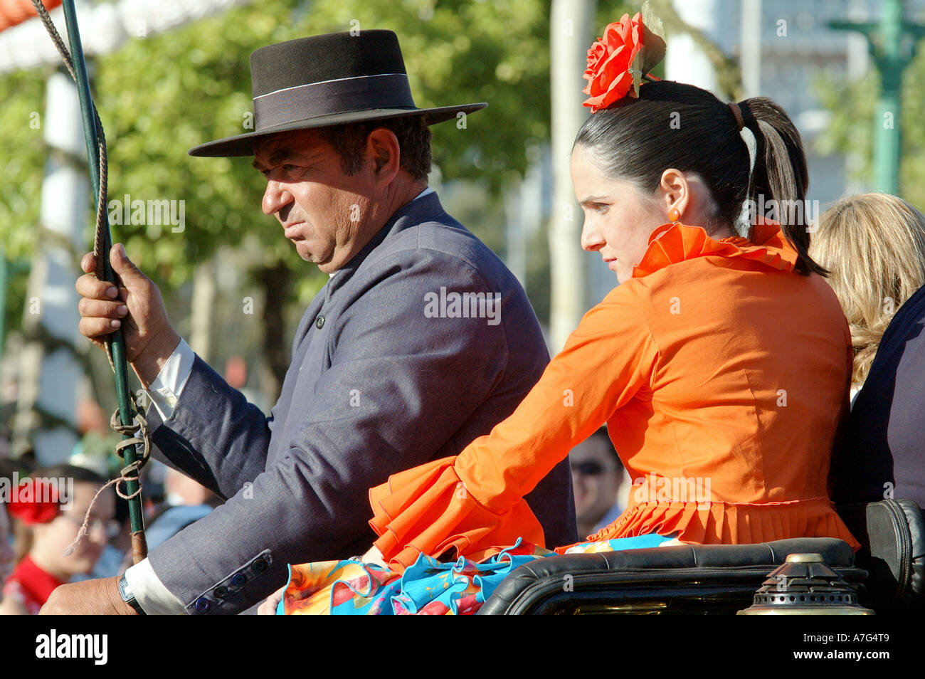 Carriage driver with a whip and a girl in an orange flamenco dress at ...