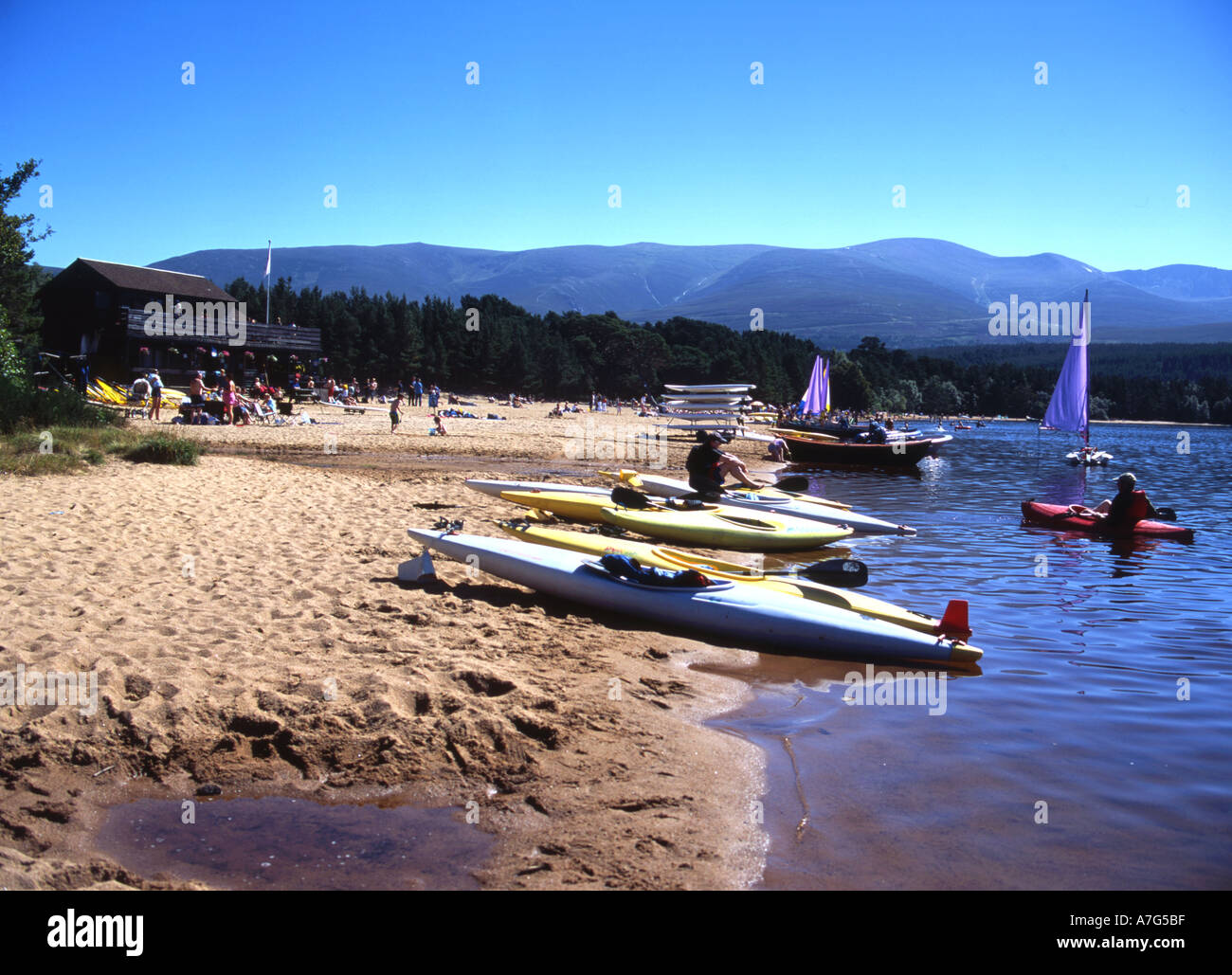 Cairn Gorm from Loch Morlich beach with sailing boats and kayaks Stock ...