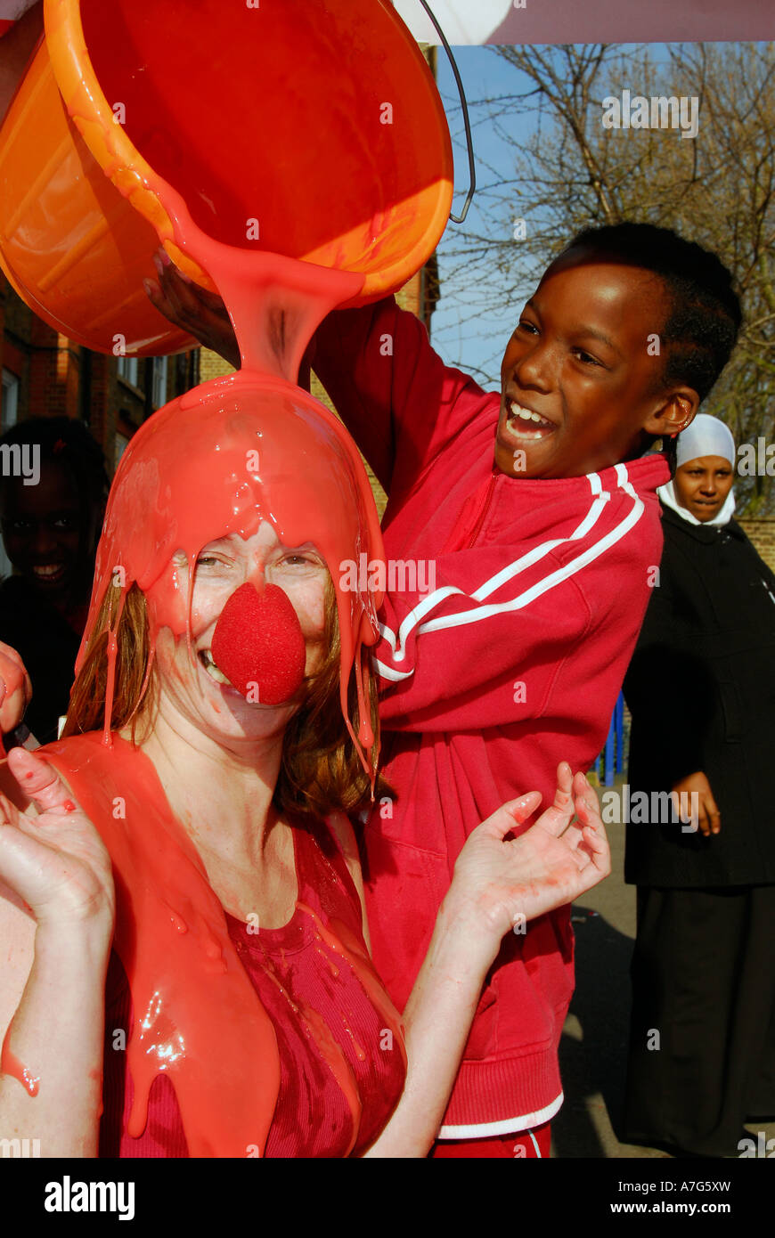 School pupil gunging his teacher on Red Nose Day for Comic Relief Stock ...