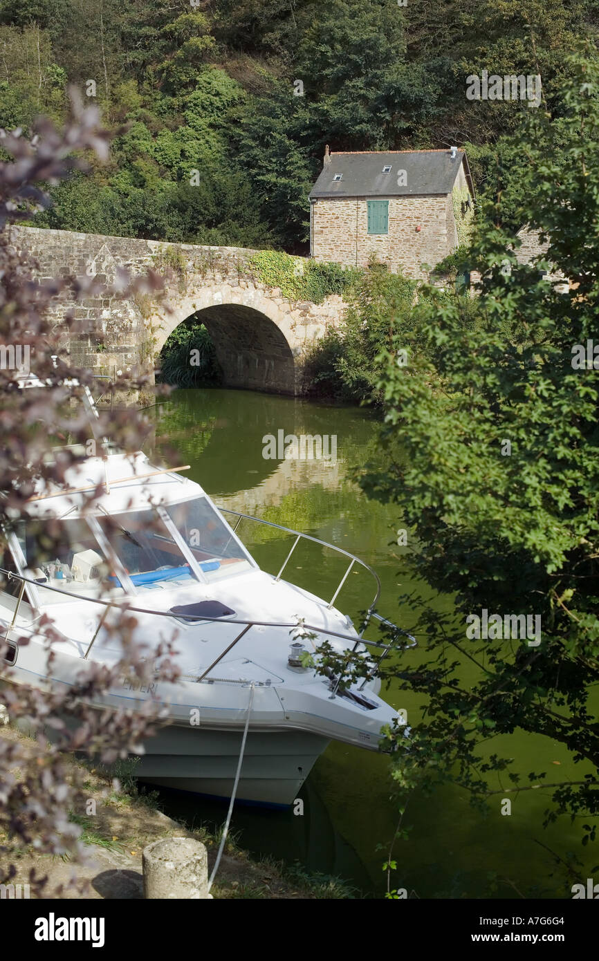 MOTORBOAT AND ANCIENT BRIDGE ON NAPOLEON CANAL LEON NEAR DINAN BRITTANY ...