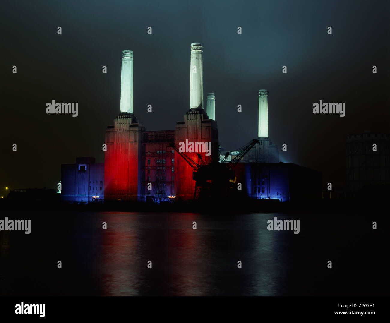 Battersea Power Station on the River Thames in London spotlit at night ...