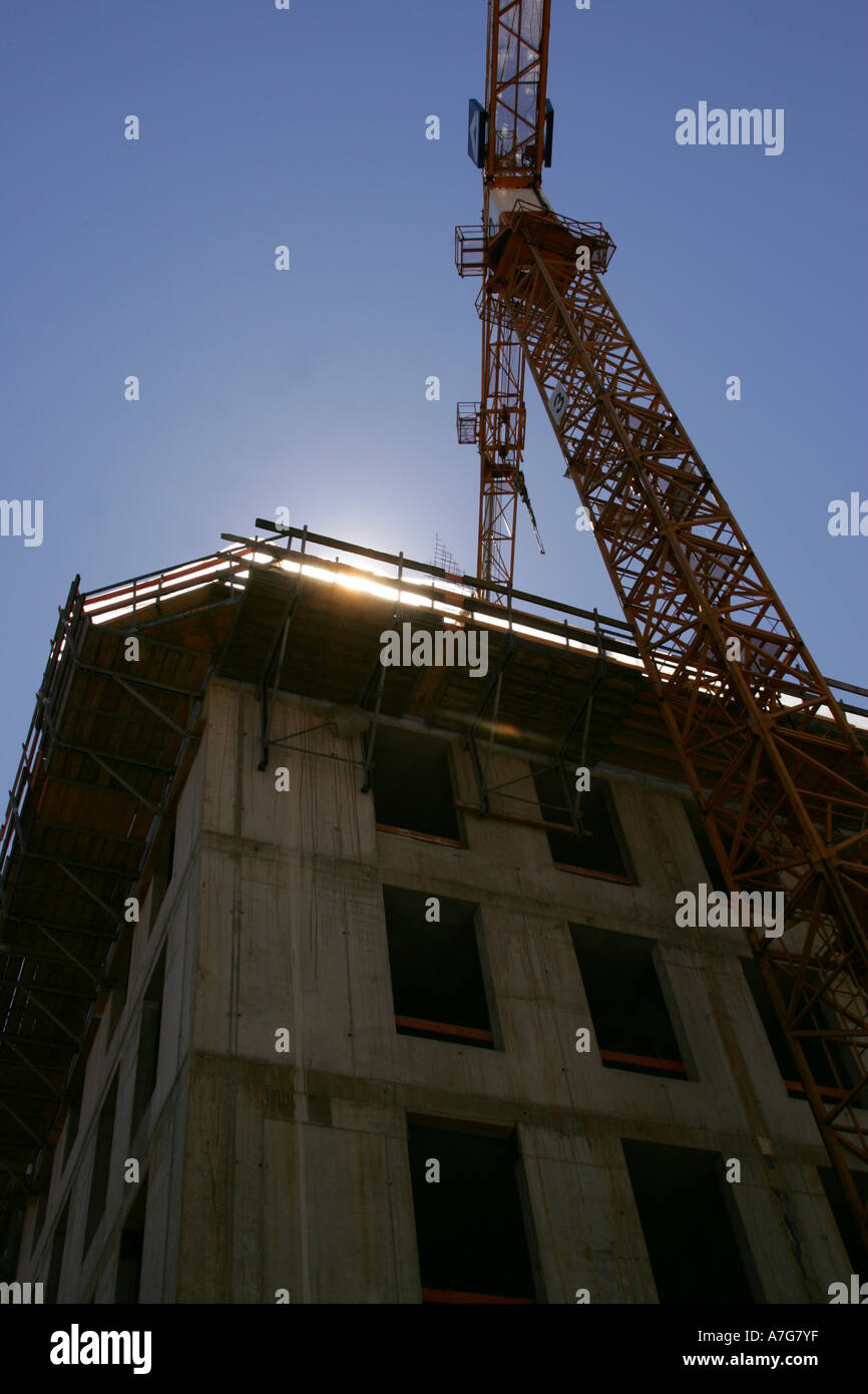 Crane over building under construction Stock Photo - Alamy