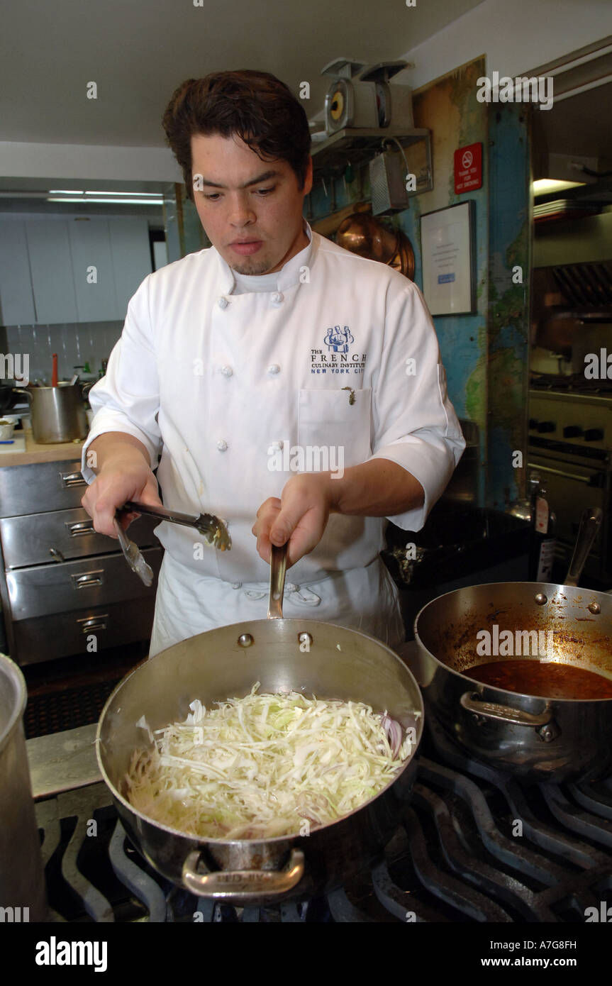 Chef from the French Culinary Institute sautes onions Stock Photo - Alamy