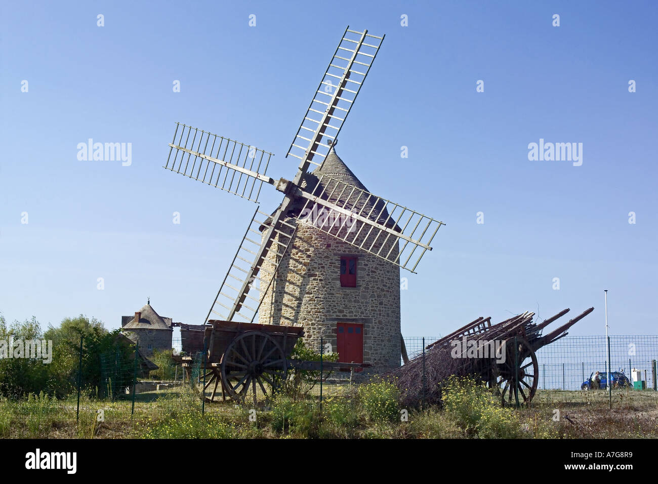 ANCIENT FARM CARTS AND WINDMILL BRITTANY FRANCE Stock Photo - Alamy