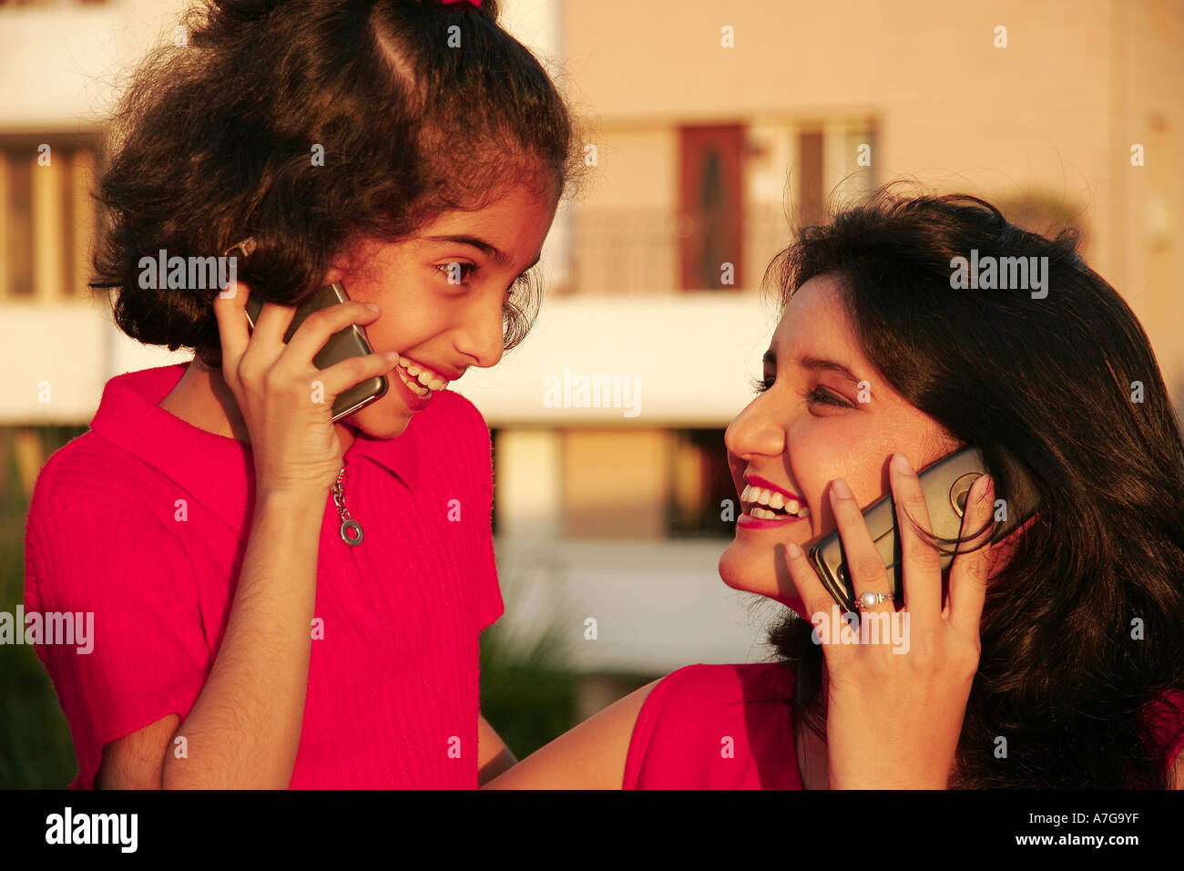 Sisters talking on mobile laughing phone Model Release Nos 191 592 ...