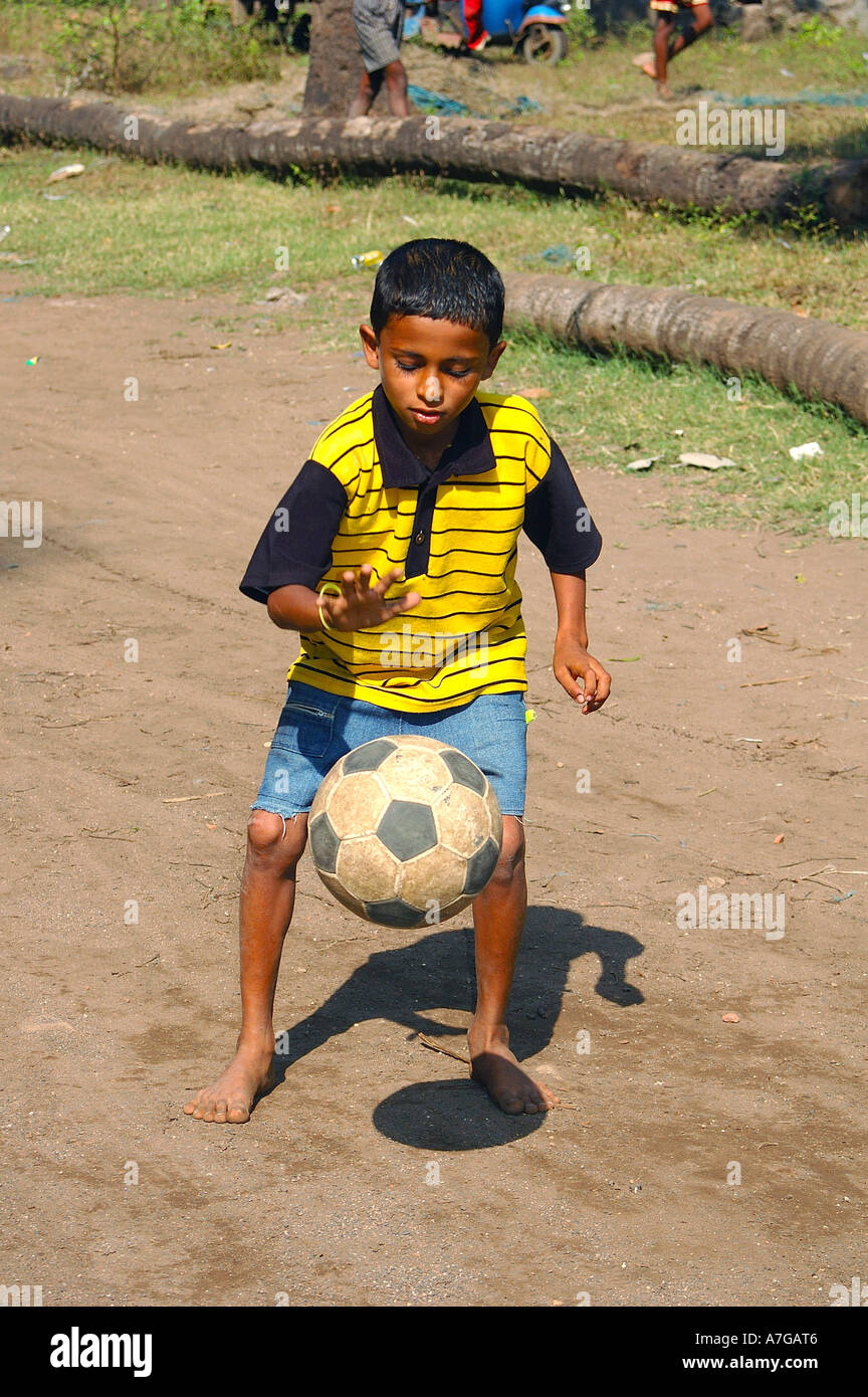 PKB77946 Indian boy playing football Stock Photo - Alamy