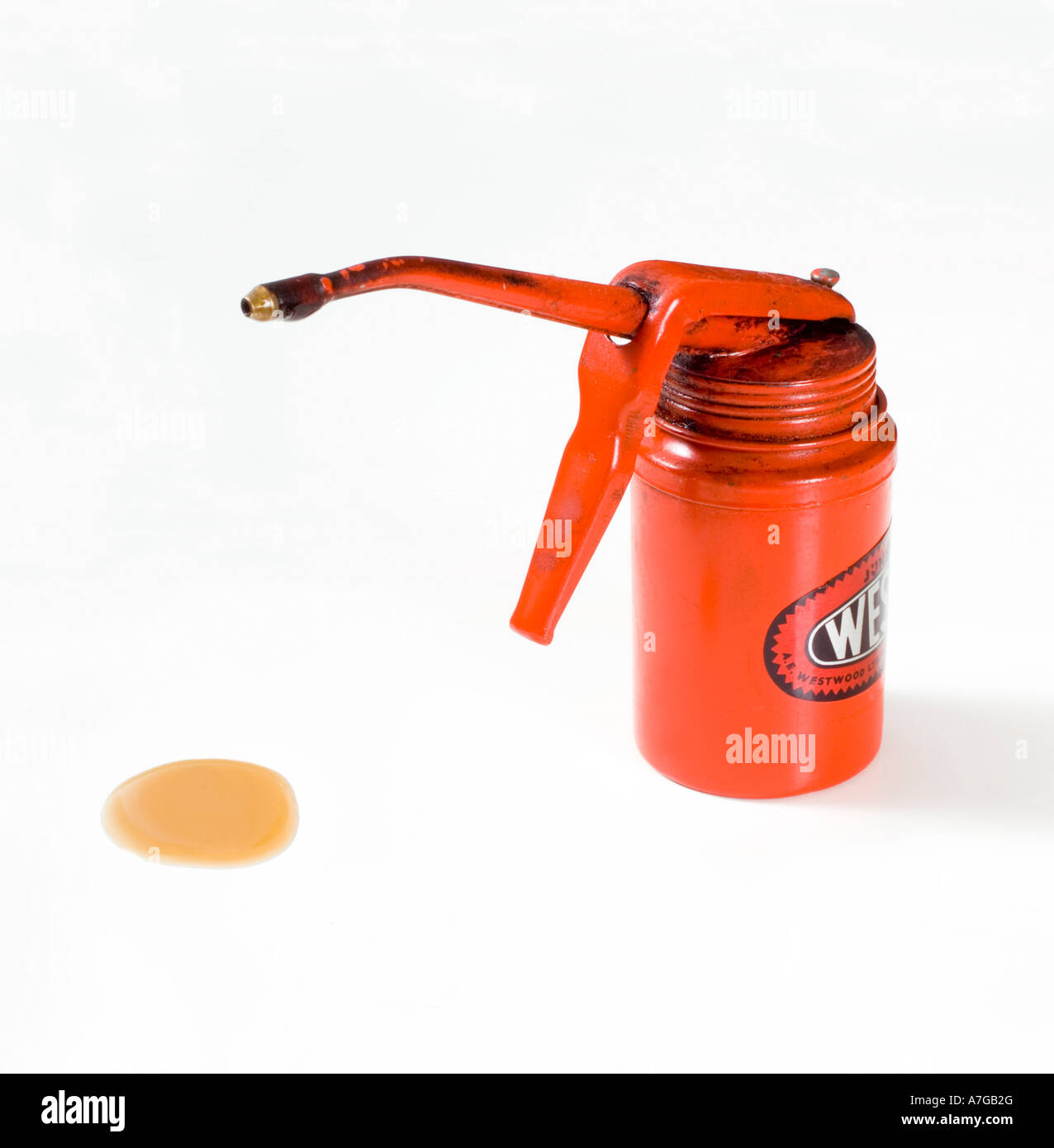 Red oil can against white background with pool of oil Stock Photo - Alamy