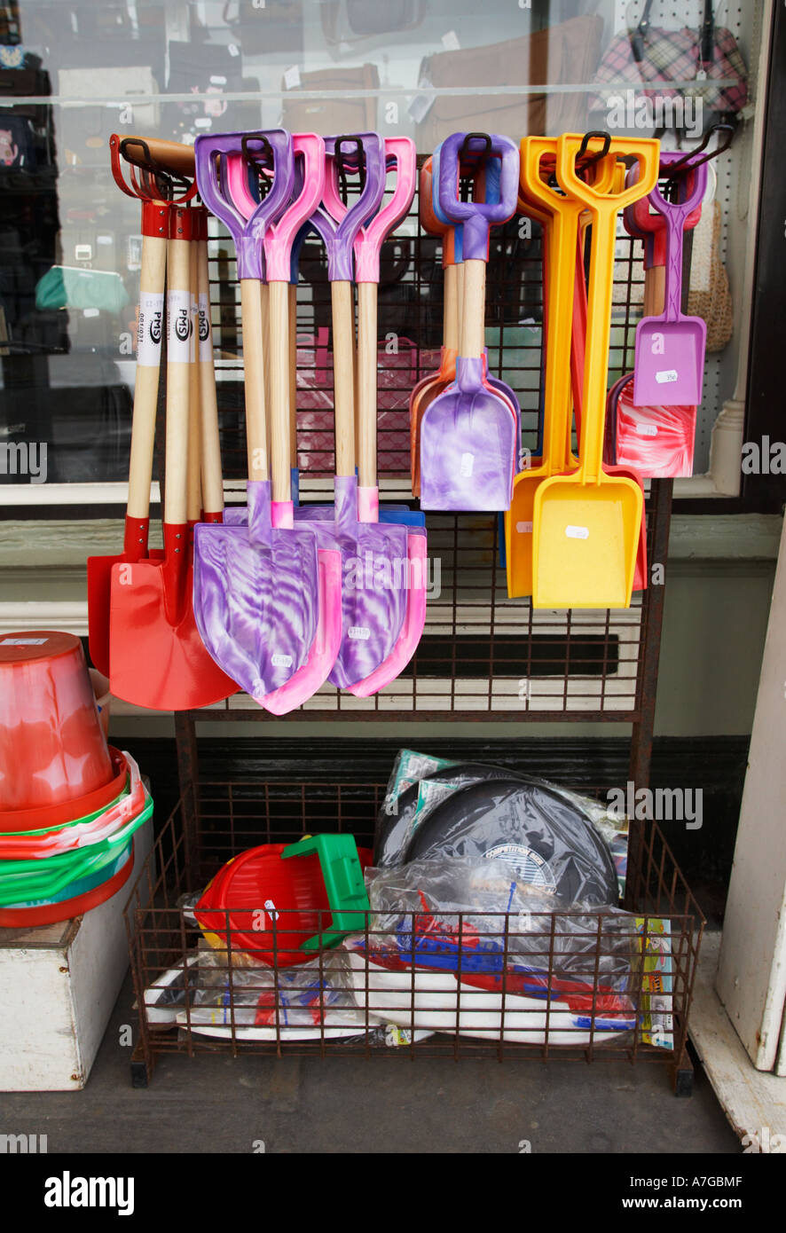 Bucket and spade rack at a seafront store England UK Stock Photo - Alamy