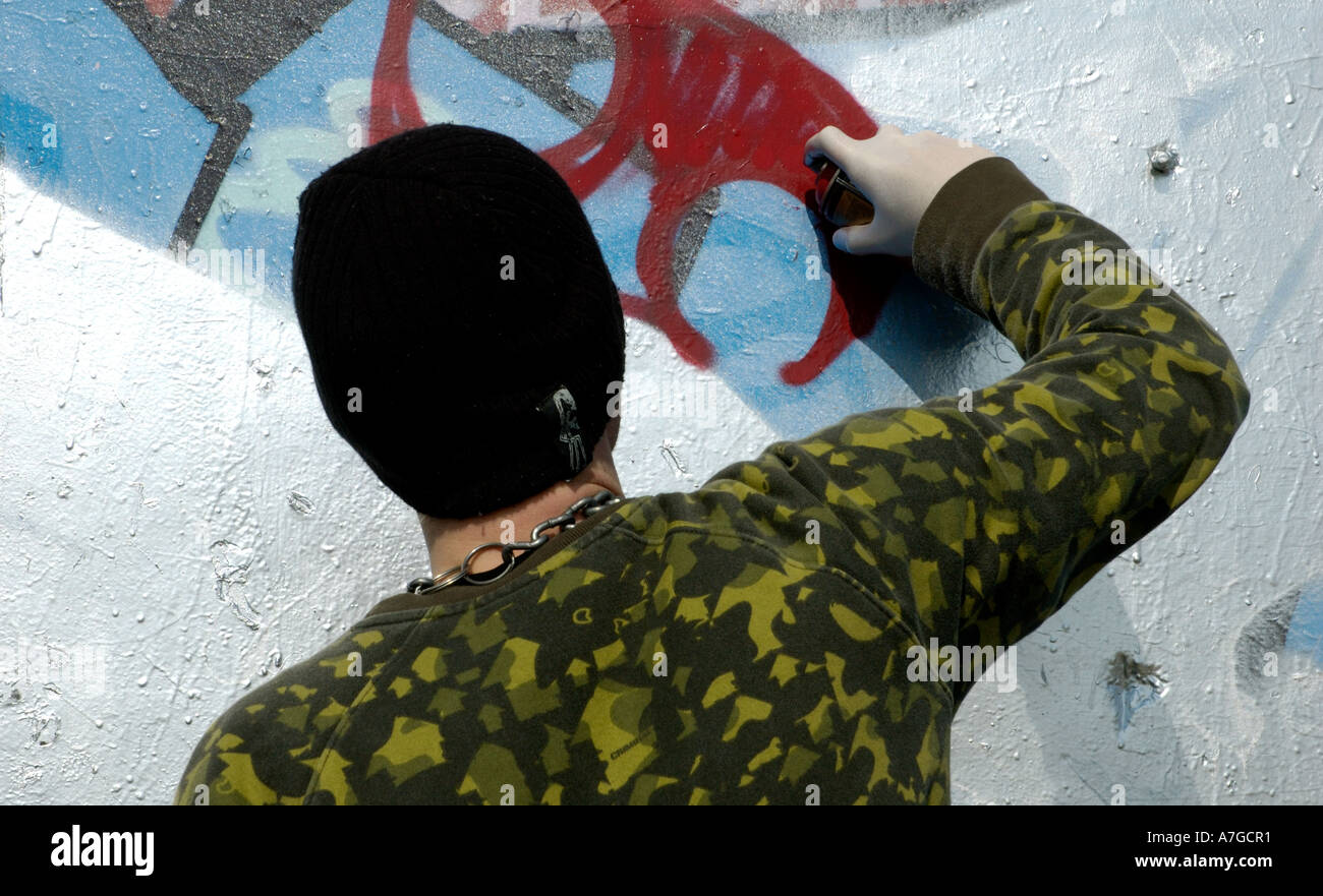 Graffiti young guy draws on hi-res stock photography and images - Alamy