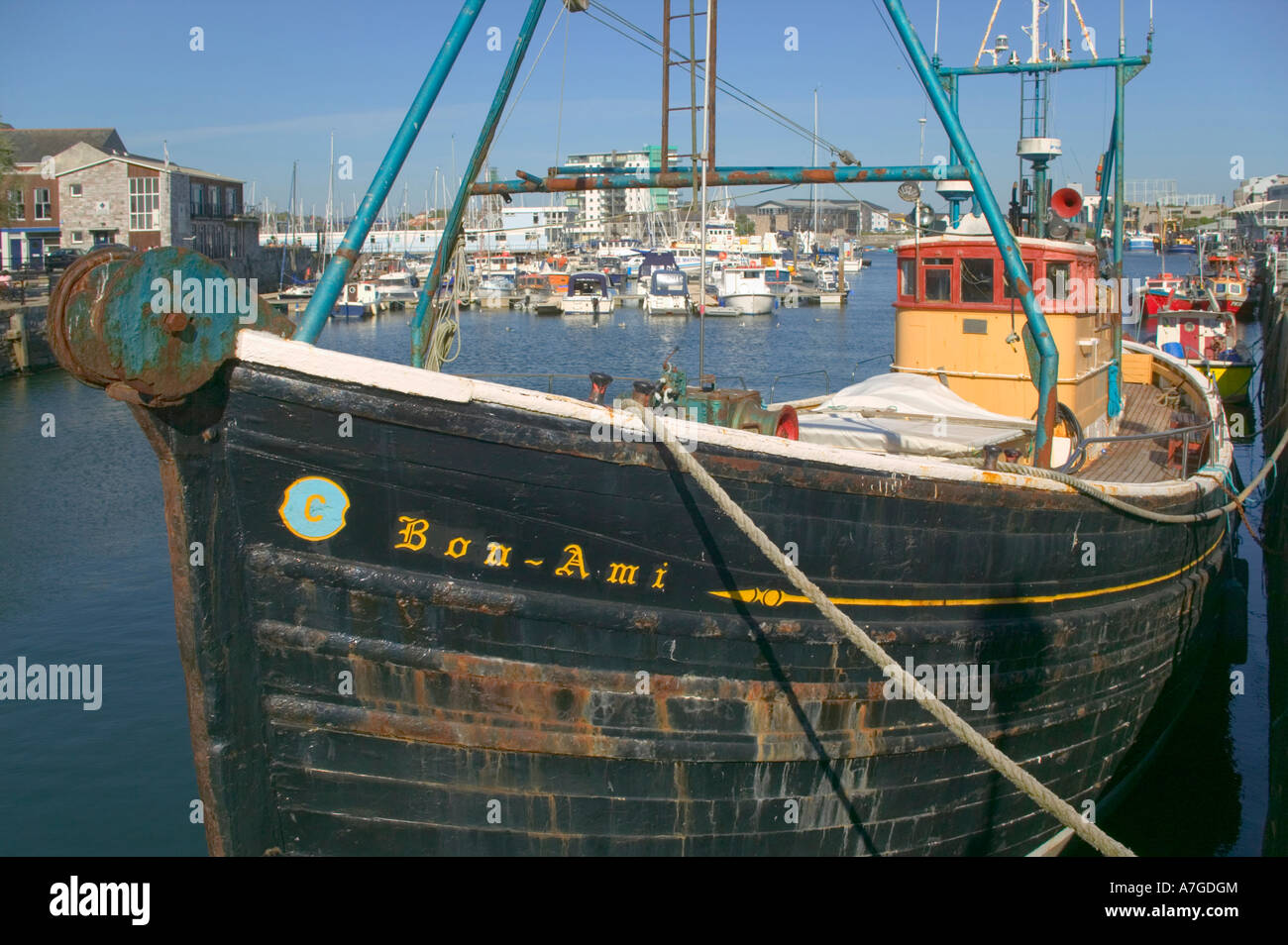An old fishing boat tied up in Sutton Harbour alongside the Barbican ...