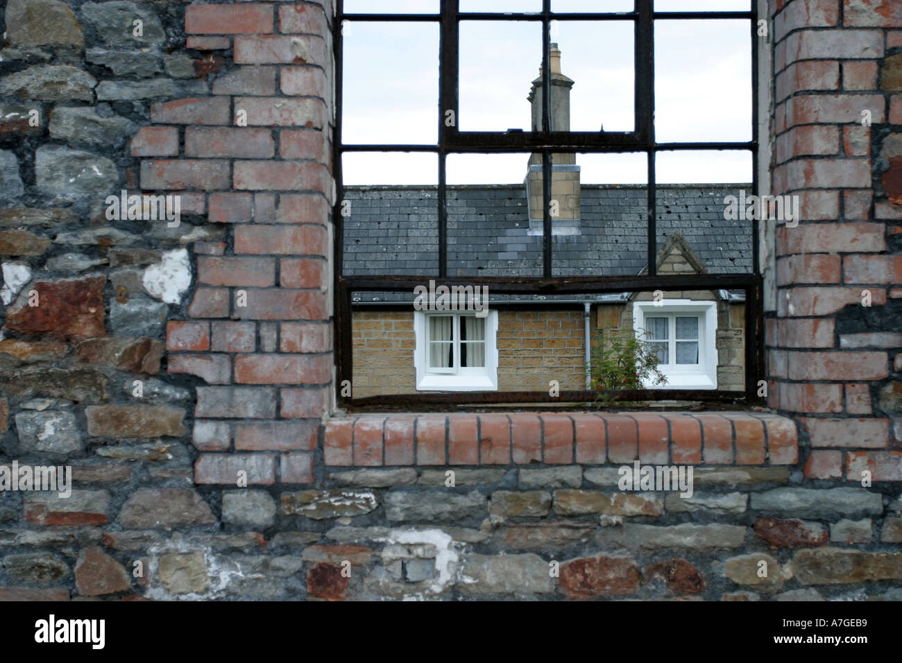Windows of a railway workers cottage viewed through the windows of a ...