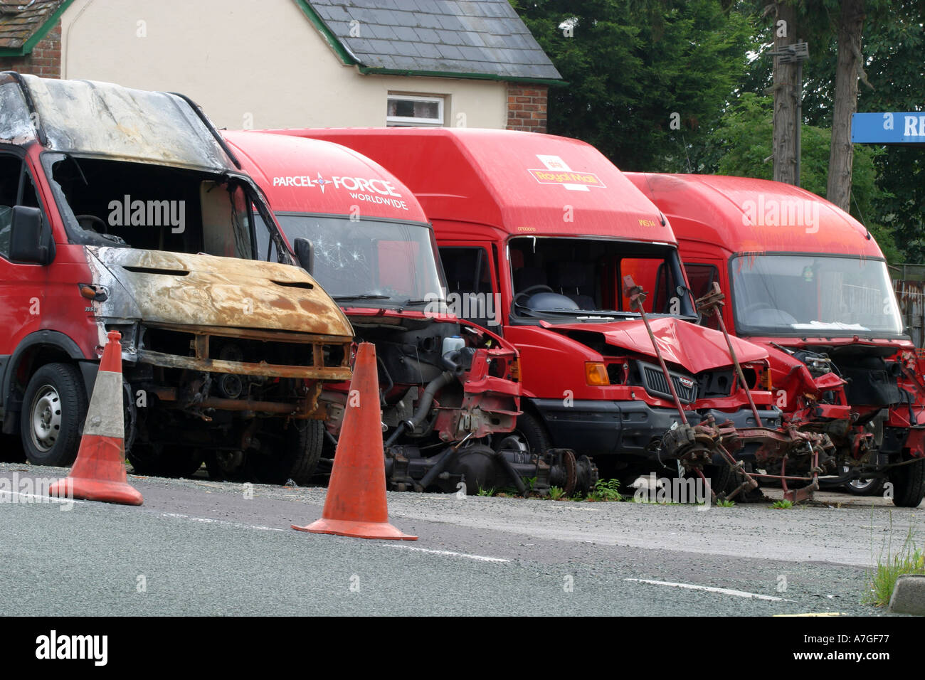 Accident damaged Royal Mail and Post Office vans on a garage forecourt ...