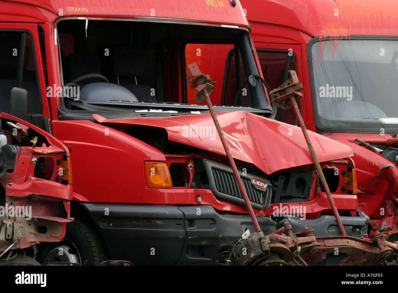 Accident damaged Royal Mail and Post Office vans on a garage forecourt ...