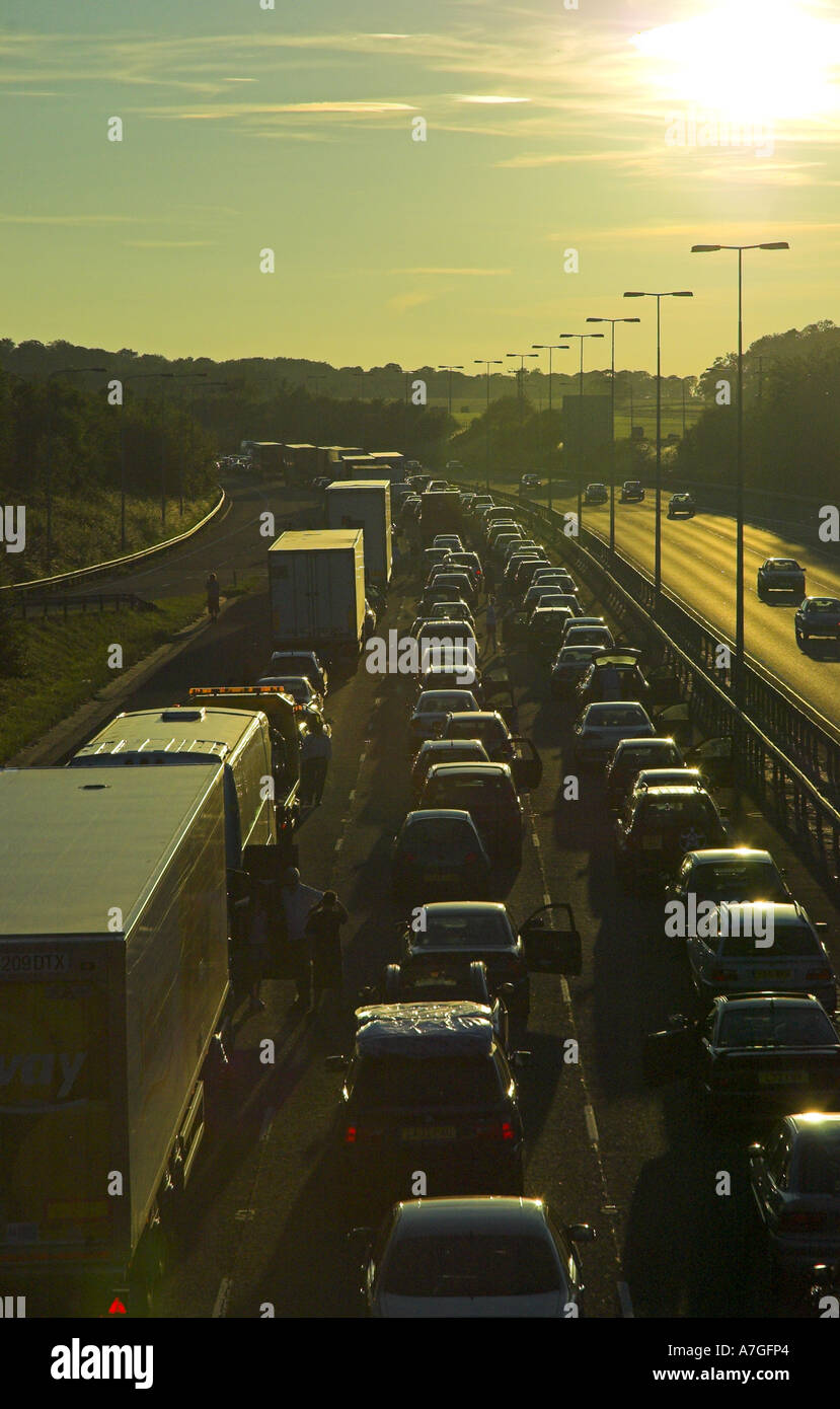 Queues of motorway traffic in the setting sun Congestion pollution ...