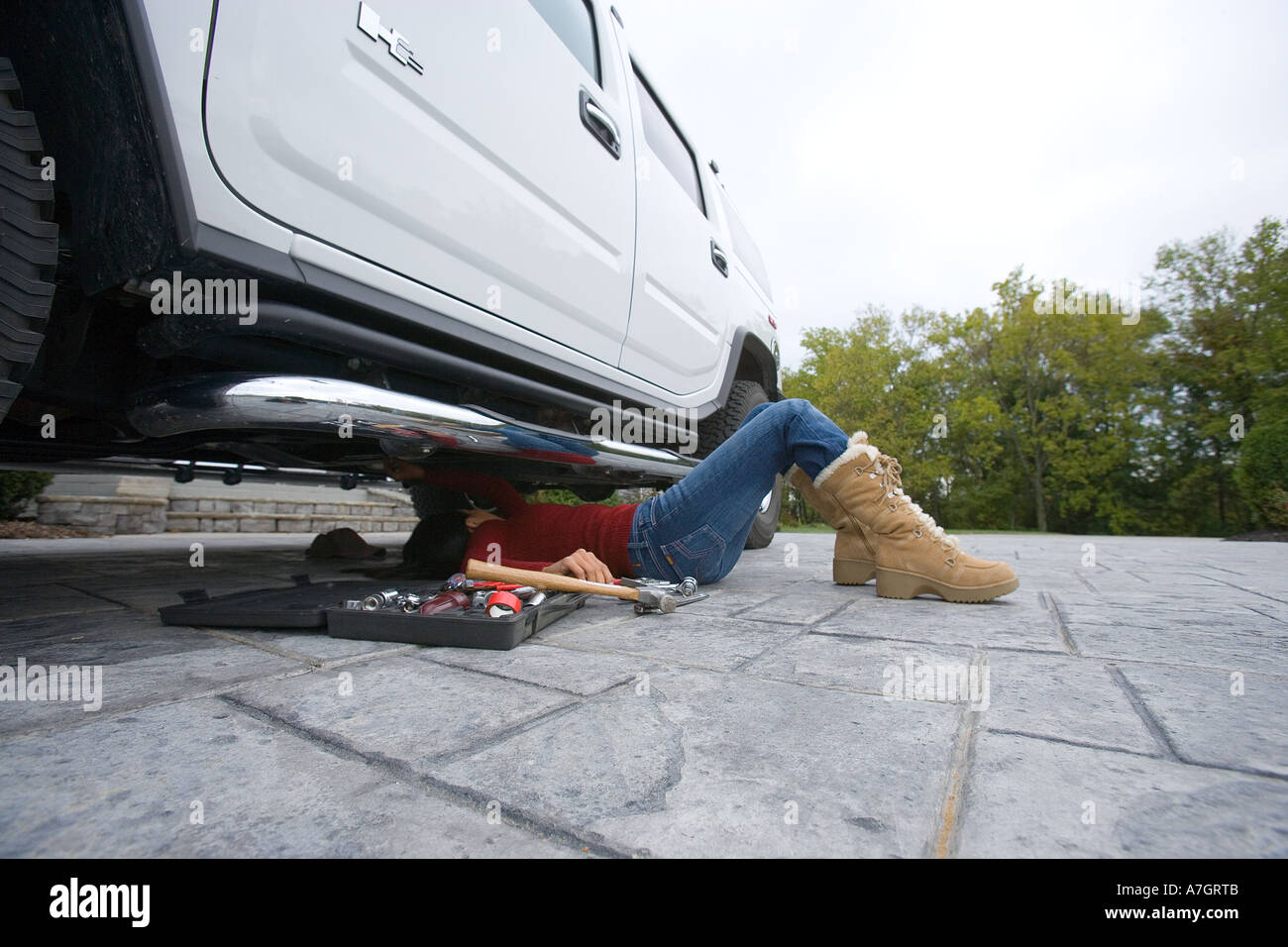 Woman working on Hummer Stock Photo - Alamy