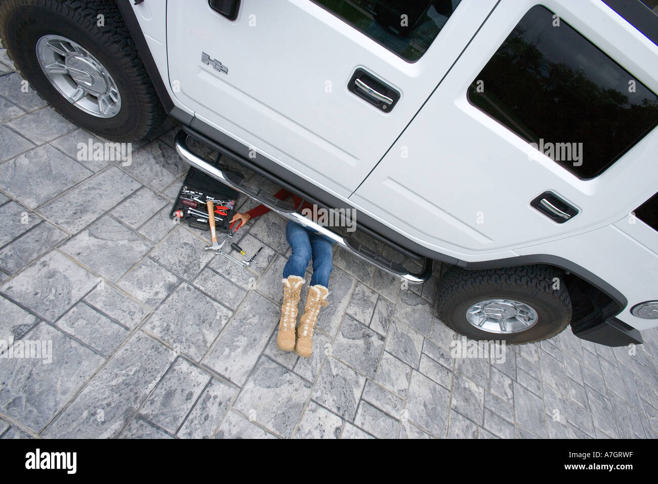 Woman working on Hummer Stock Photo - Alamy