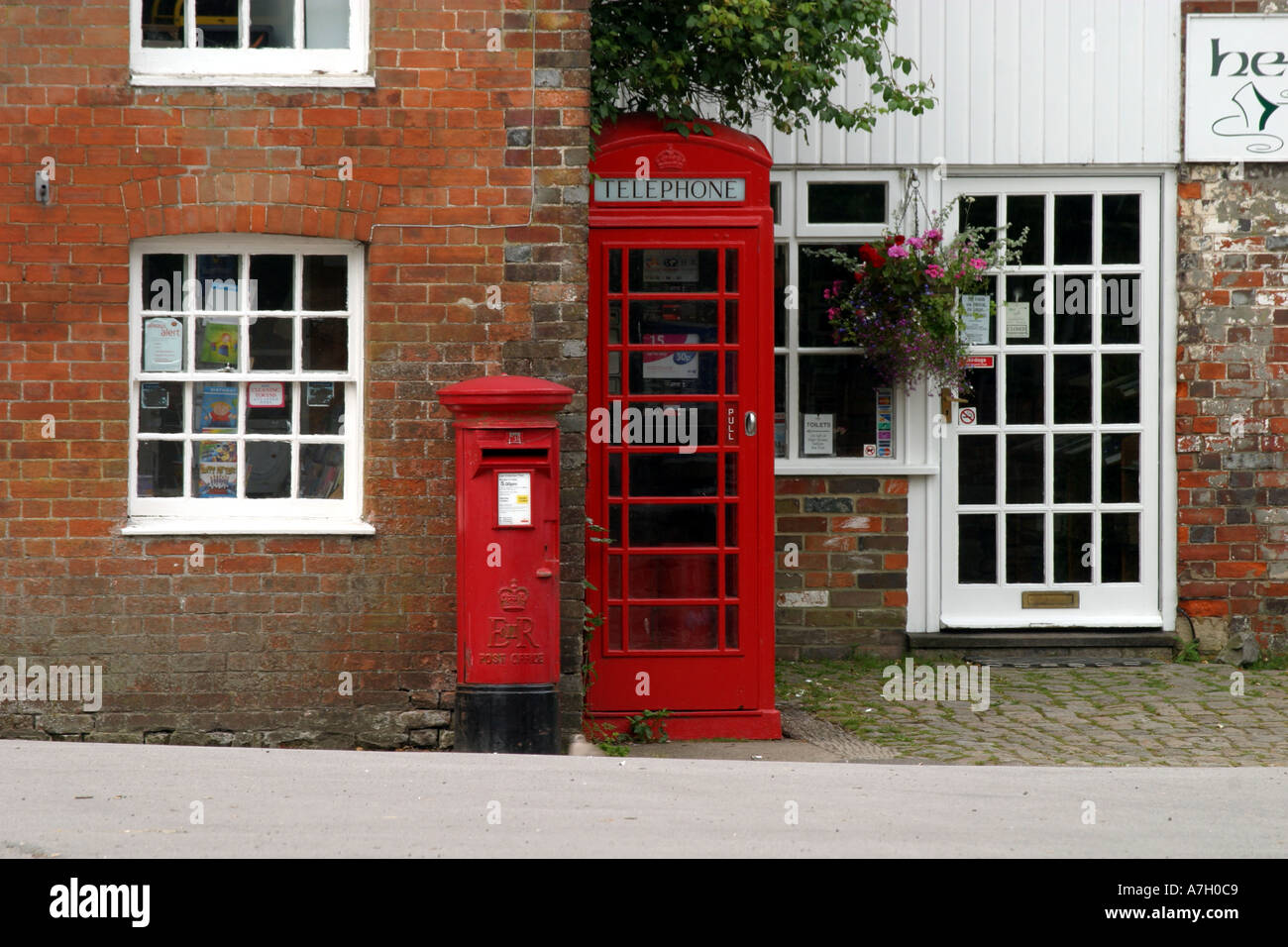 Red telephone kiosk pillar box and post office in the village of ...