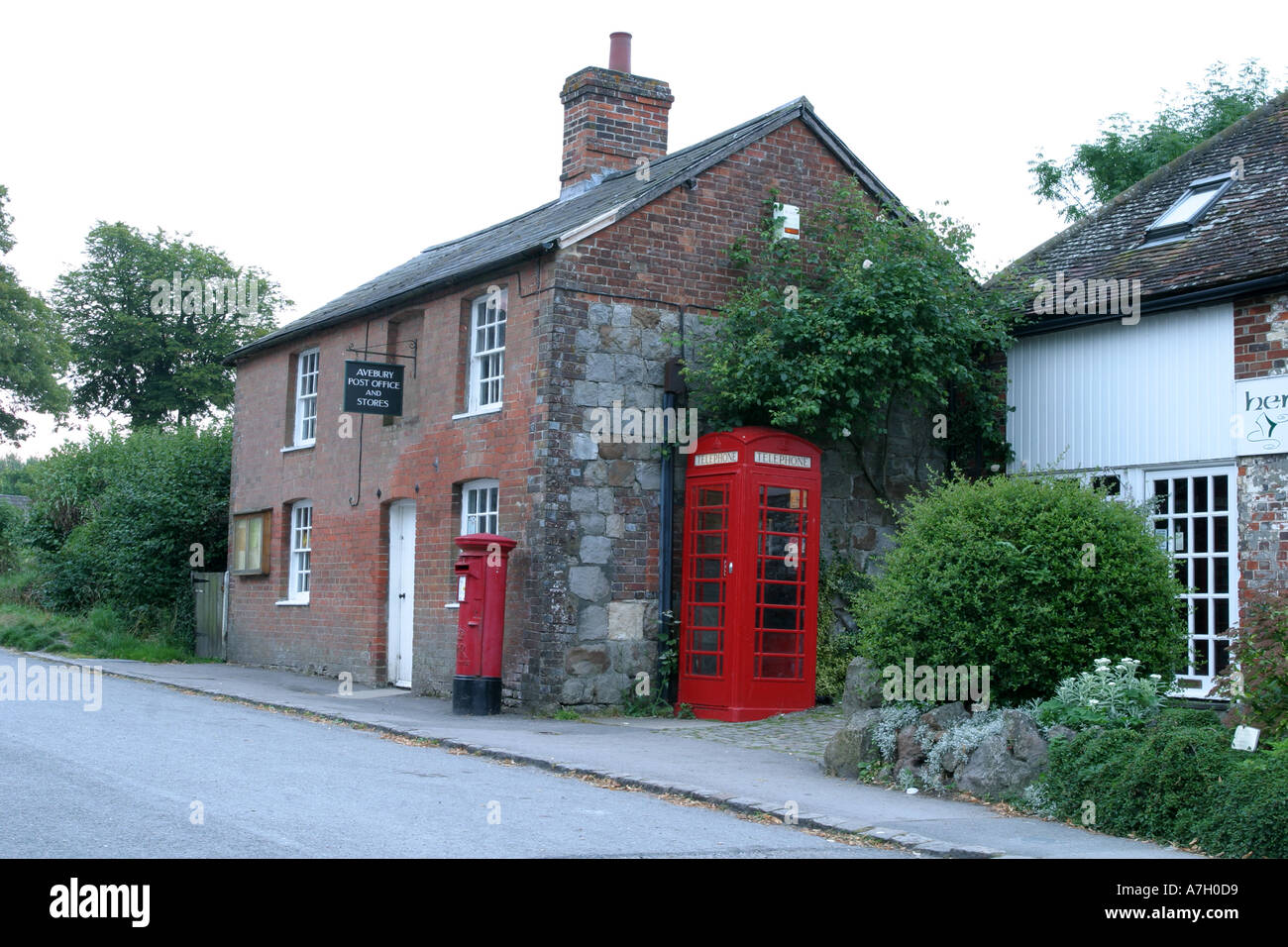 Red telephone kiosk pillar box and post office in the village of ...