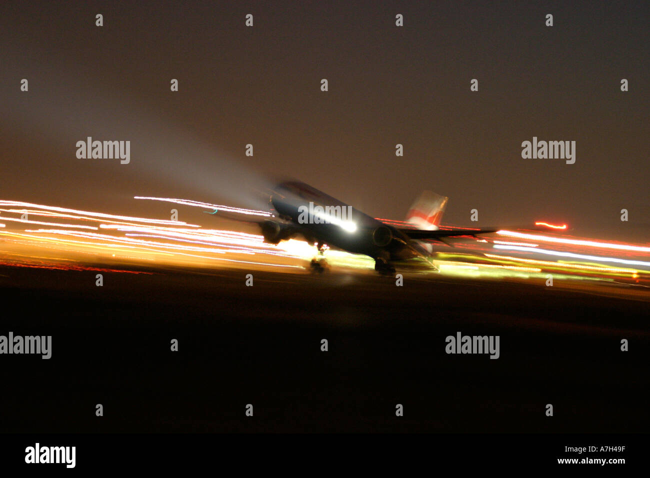 Take off - commercial jet at night Stock Photo - Alamy