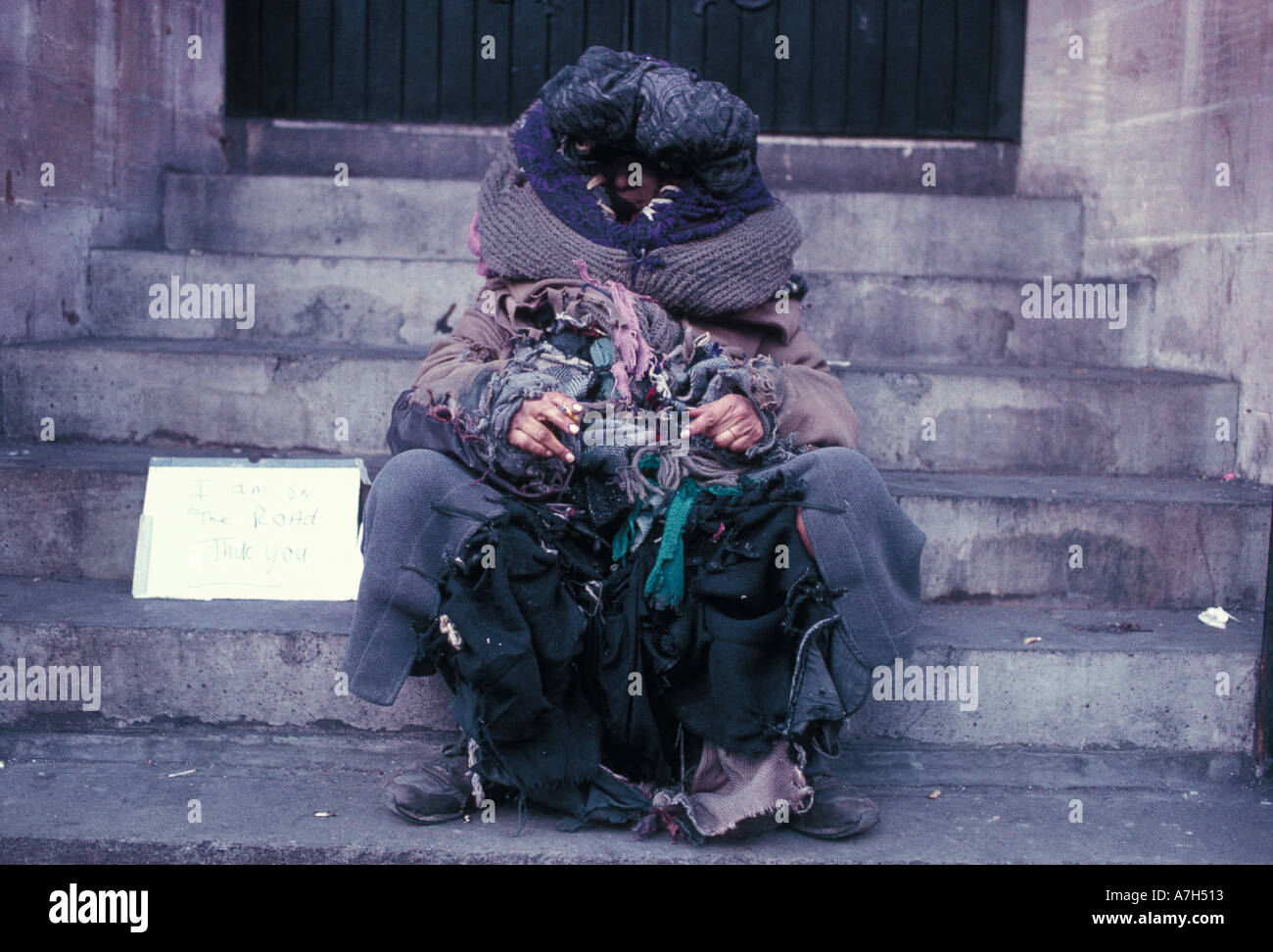 Homeless Person with begging sign Stock Photo - Alamy