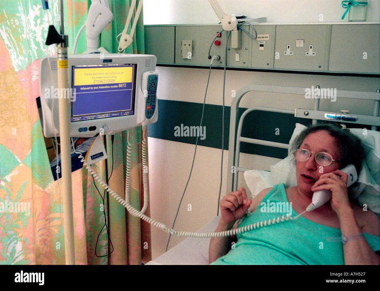 Patient in hospital bed talking on special bedside telephone Stock ...