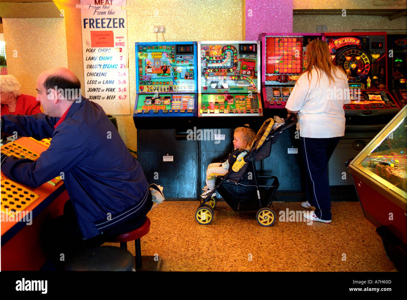 People playing bingo and slot machines in a games arcade Stock Photo ...