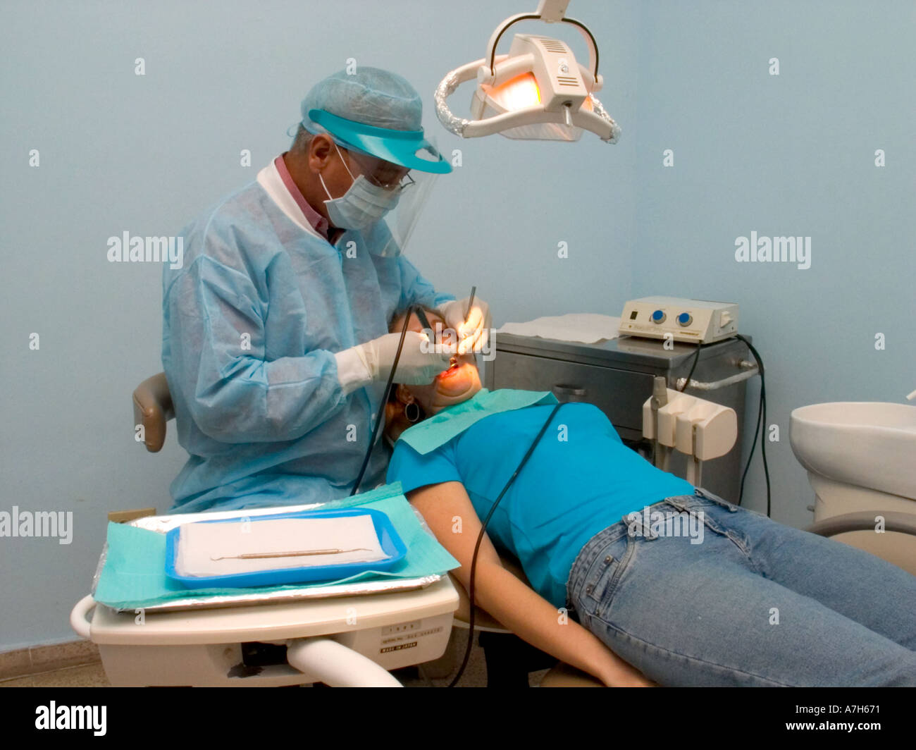 Dentist performing procedure Stock Photo - Alamy