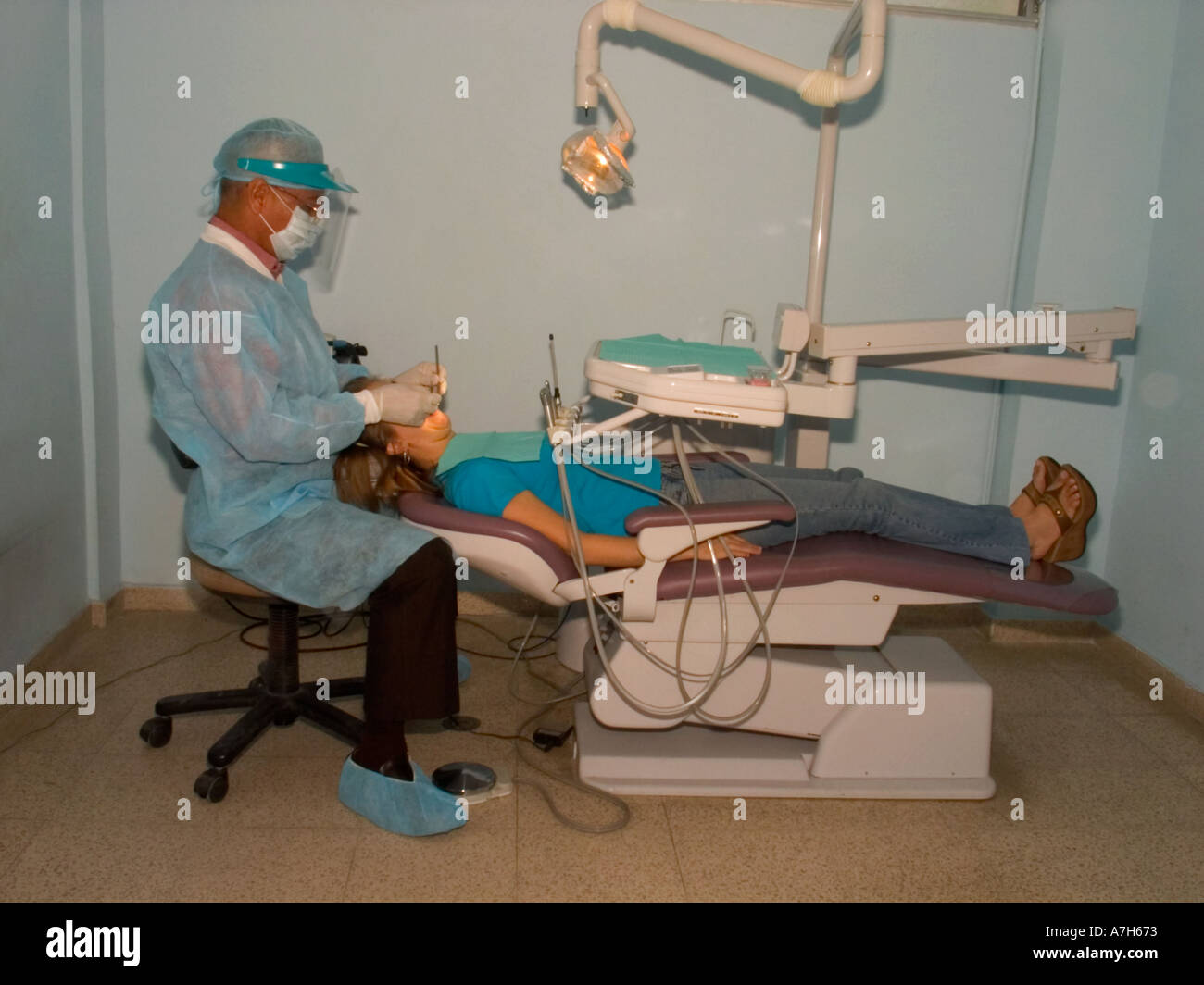 Dentist performing procedure Stock Photo - Alamy